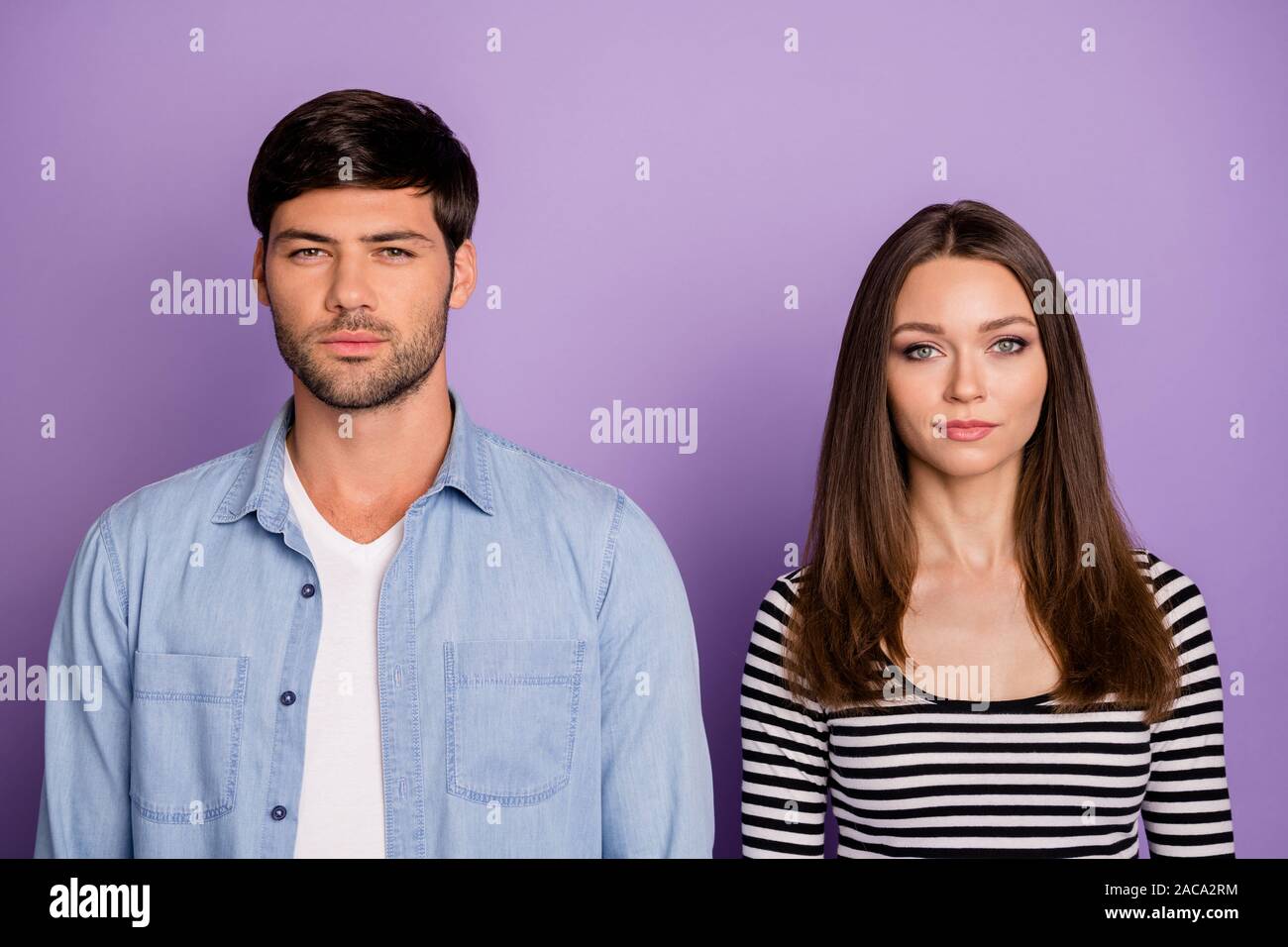 Photo of two funny people couple not smiling looking seriously on ...