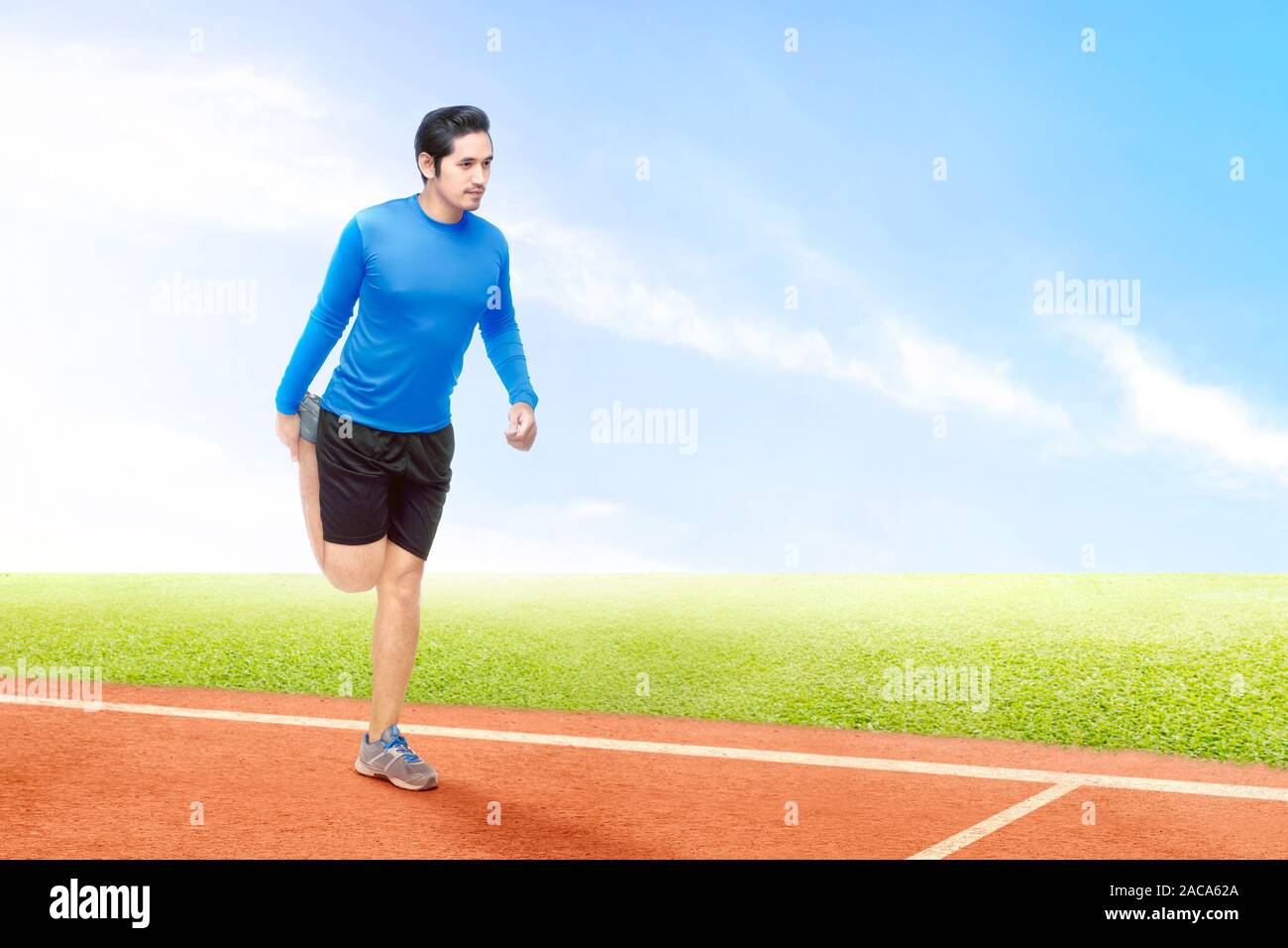 Asian runner man stretching legs before start the run on the running ...