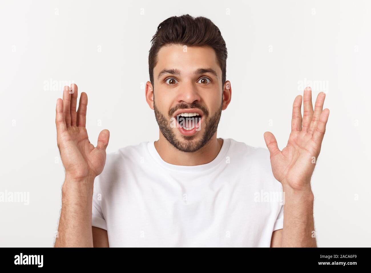 Portrait of young man with shocked facial expression, isolated over ...