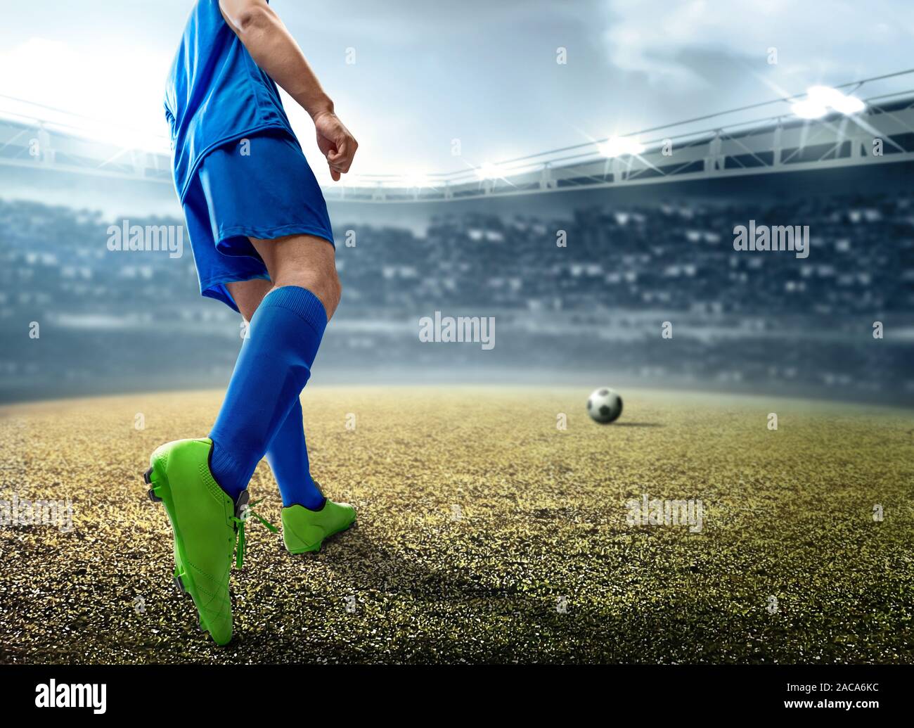 Rear view of Asian football player man kicking the ball on the football ...