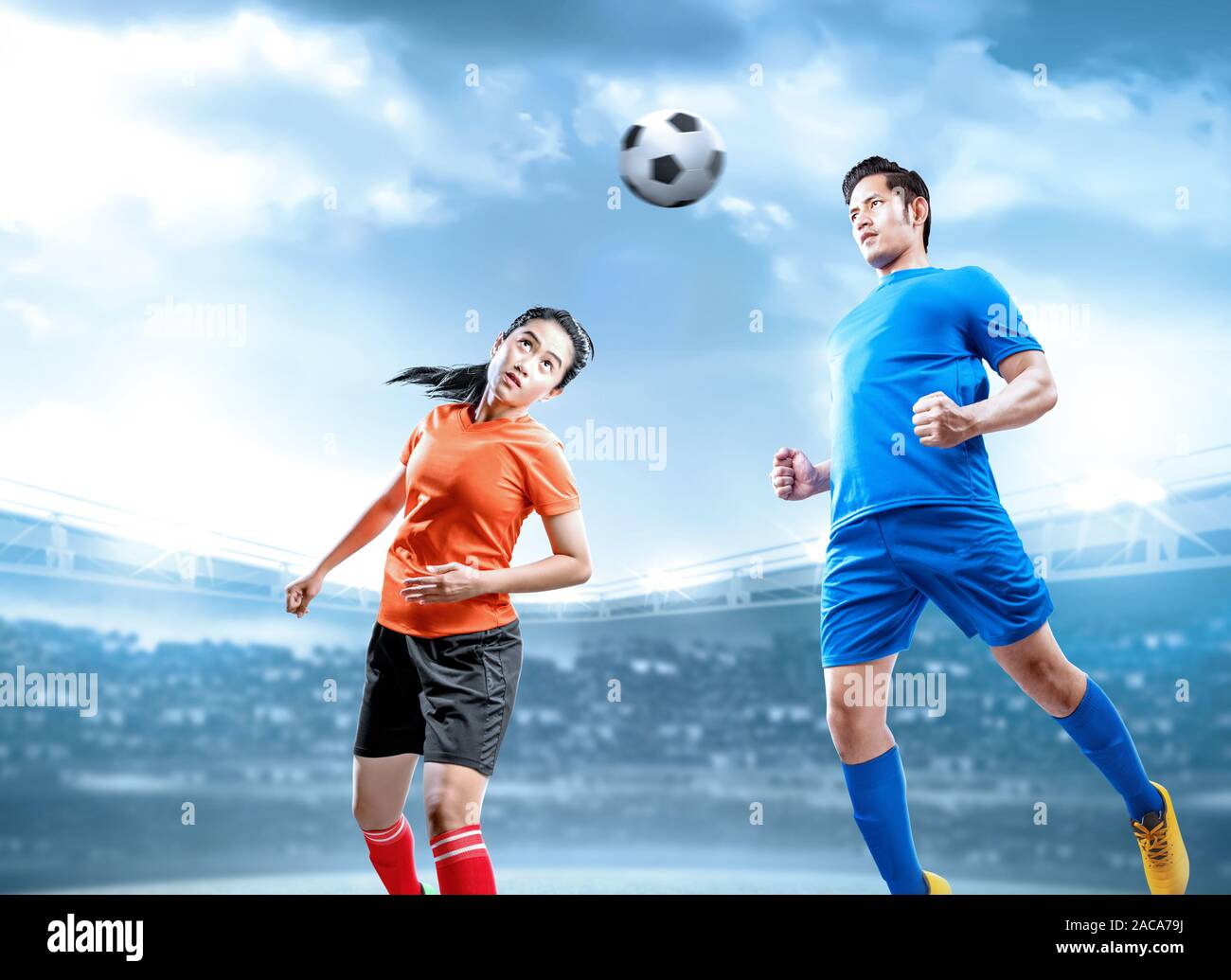 Asian football player jump and duel heading the ball on the air on the ...