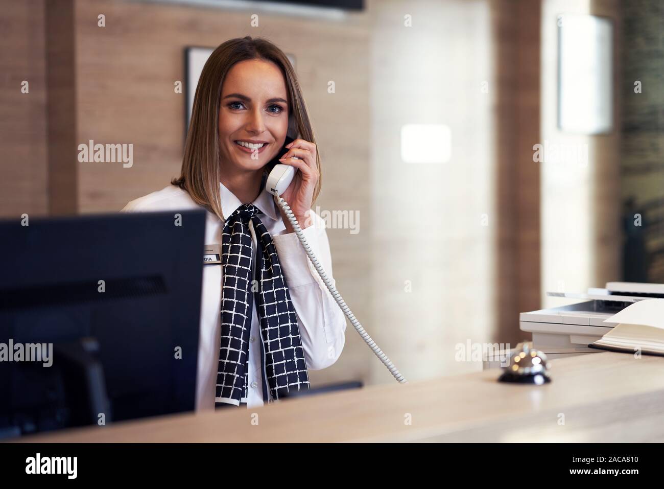 Hotel receptionist phone hi-res stock photography and images - Alamy