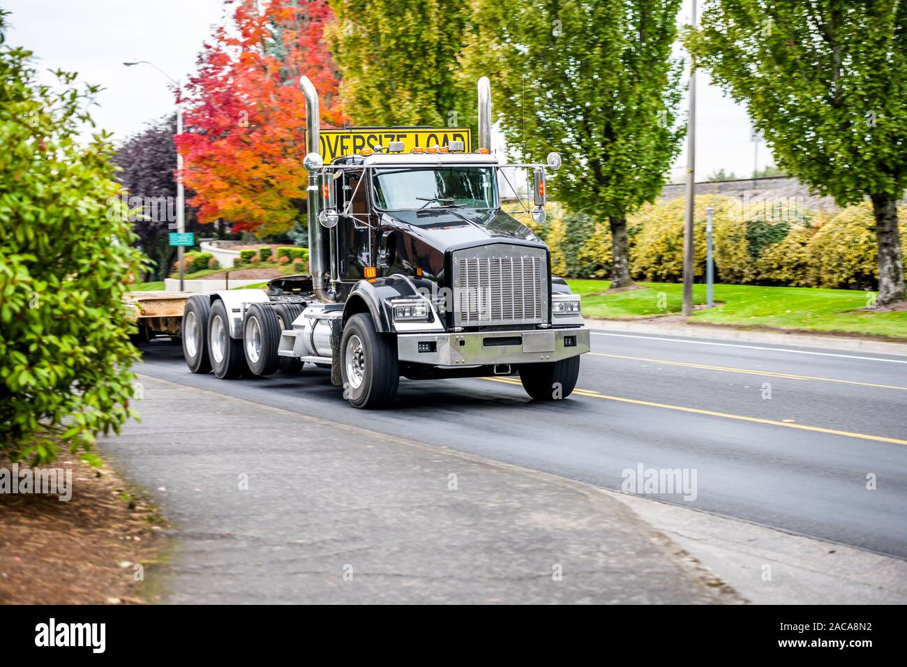 Black powerful big rig industrial semi truck with step down semi ...