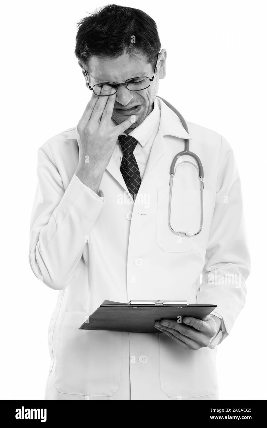 Studio shot of sad young man doctor crying while holding clipboard ...