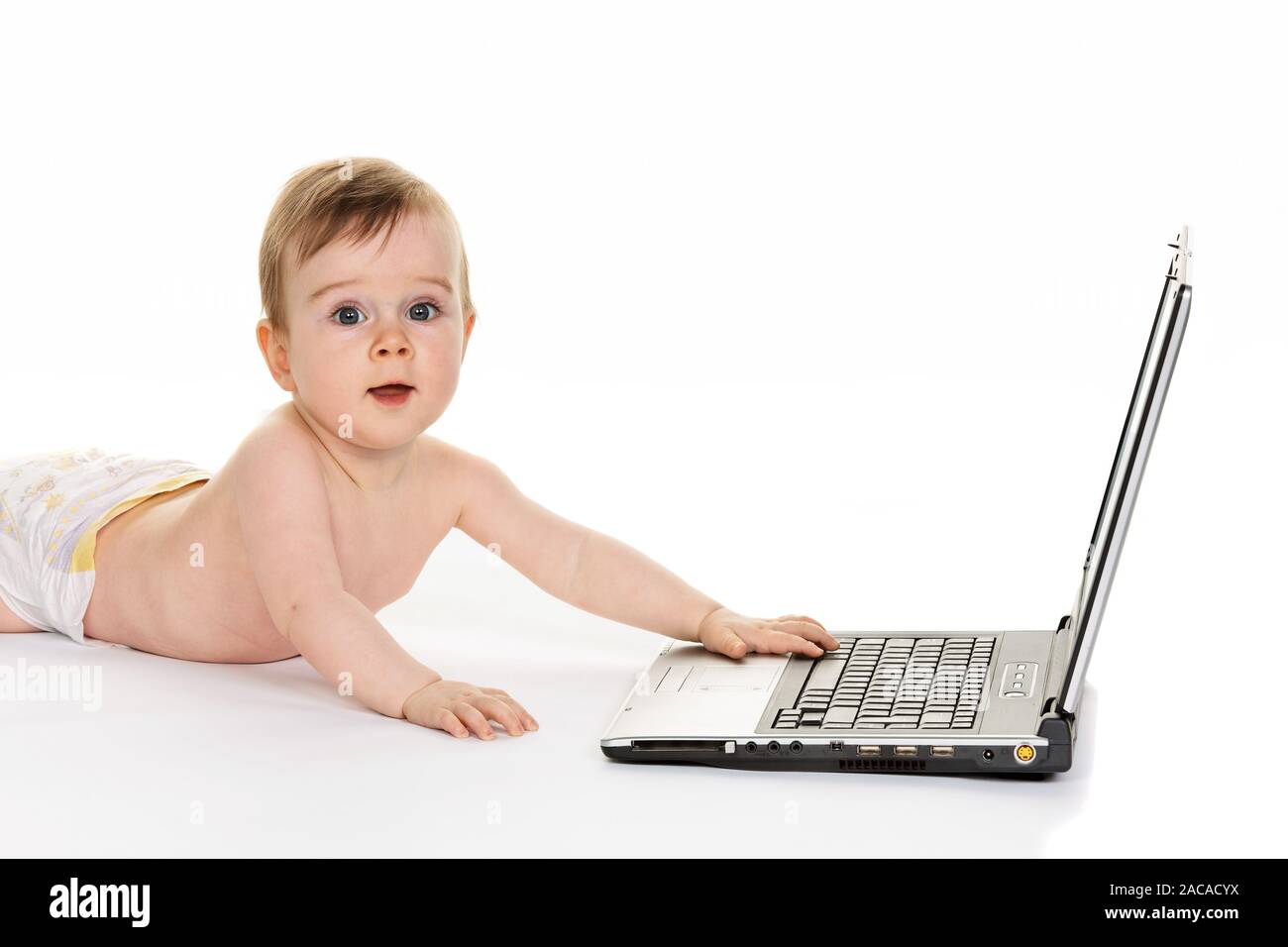 Little Child In Diapers Plays With A Laptop Computer Stock Photo - Alamy