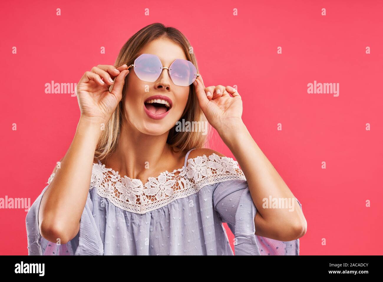 Beautiful adult woman posing over pink background Stock Photo - Alamy