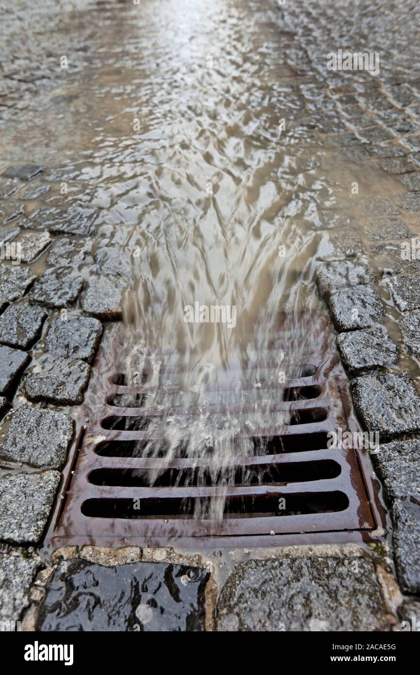 Water flows into the drain during heavy rainfall Stock Photo - Alamy