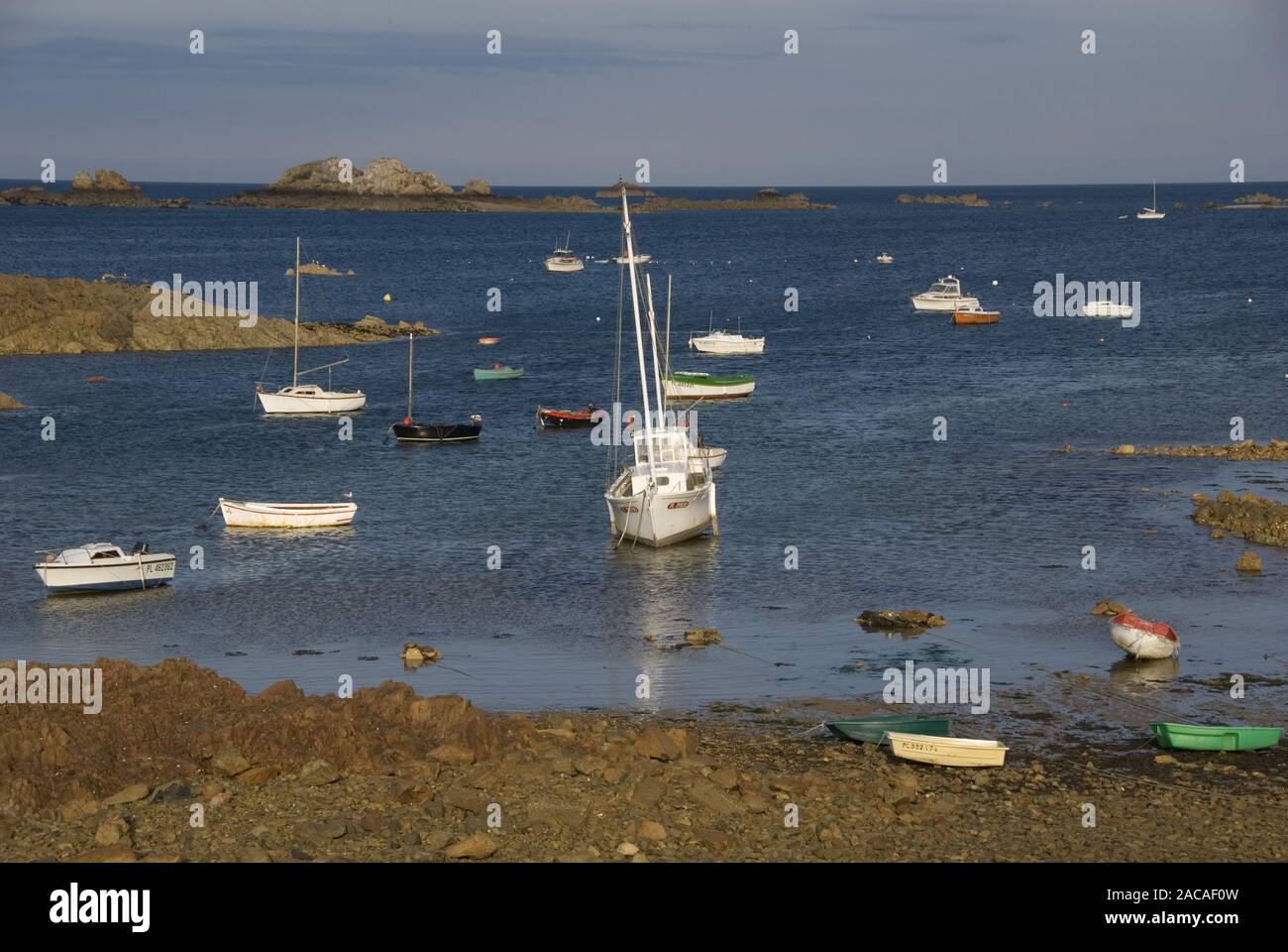Boats between rocks in the sea Stock Photo - Alamy