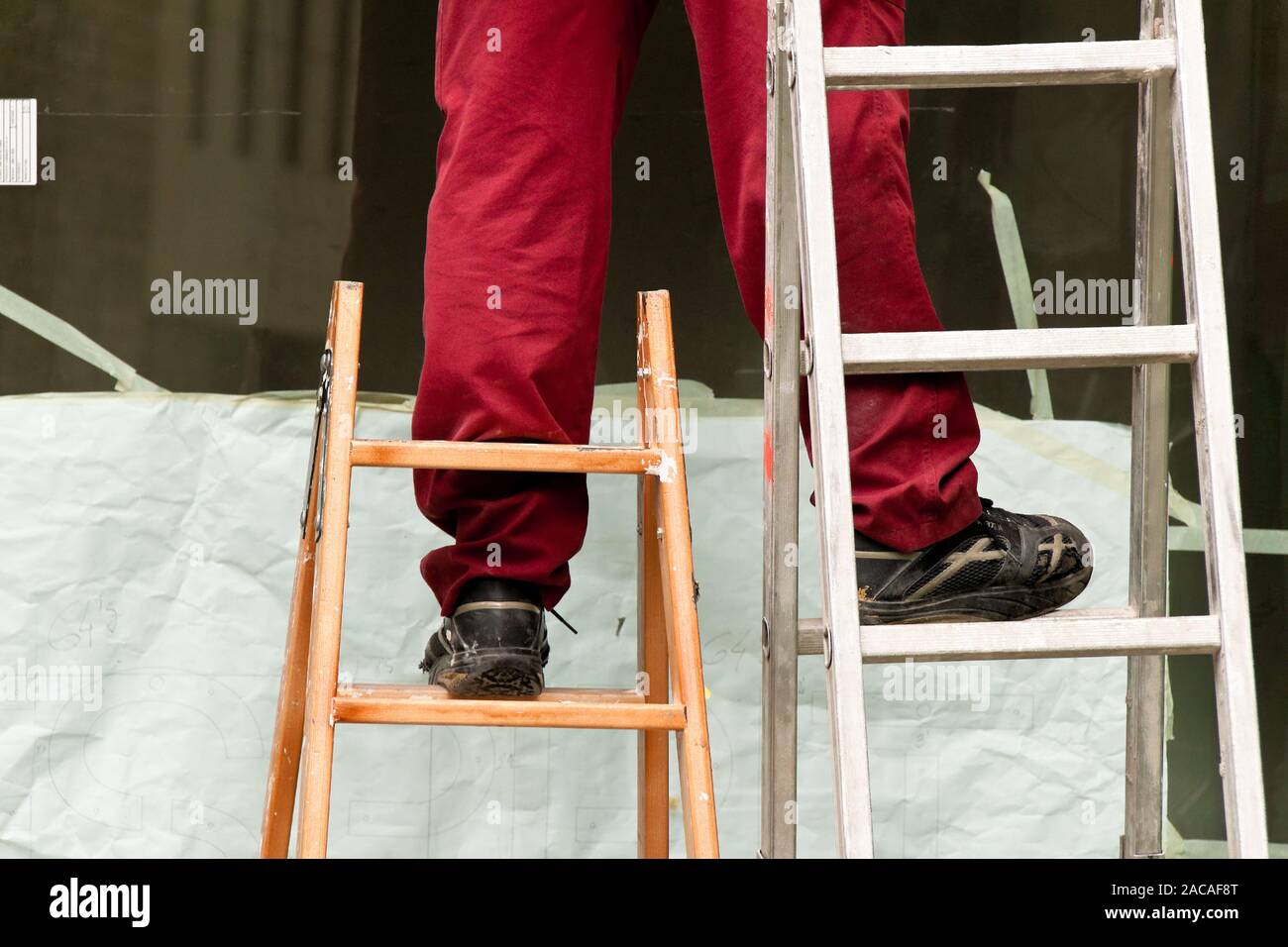 Safety at work. Man on ladder Stock Photo - Alamy