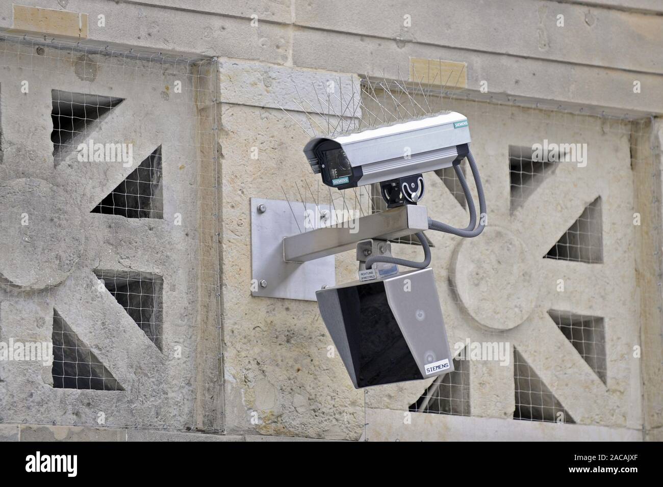 Surveillance camera with infrared motion detector Stock Photo - Alamy