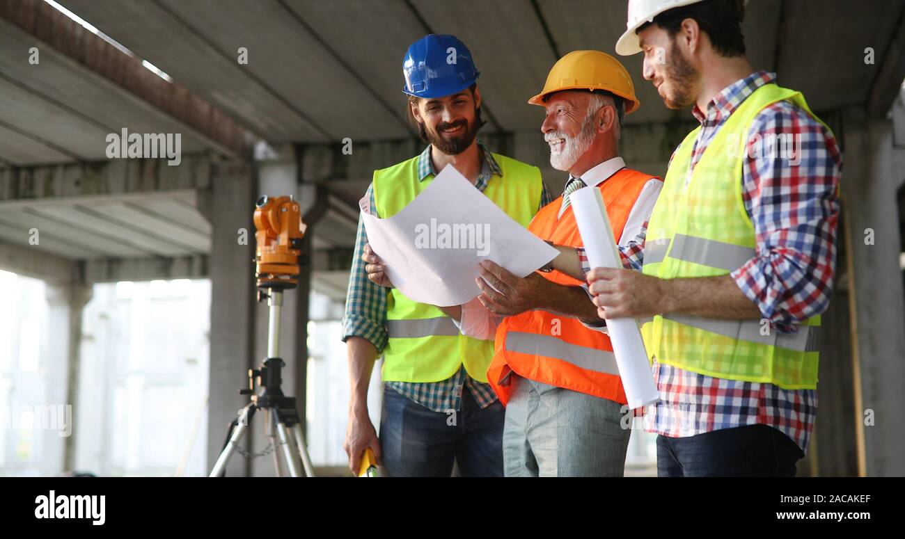 Group engineers architects discuss blueprint hi-res stock photography ...
