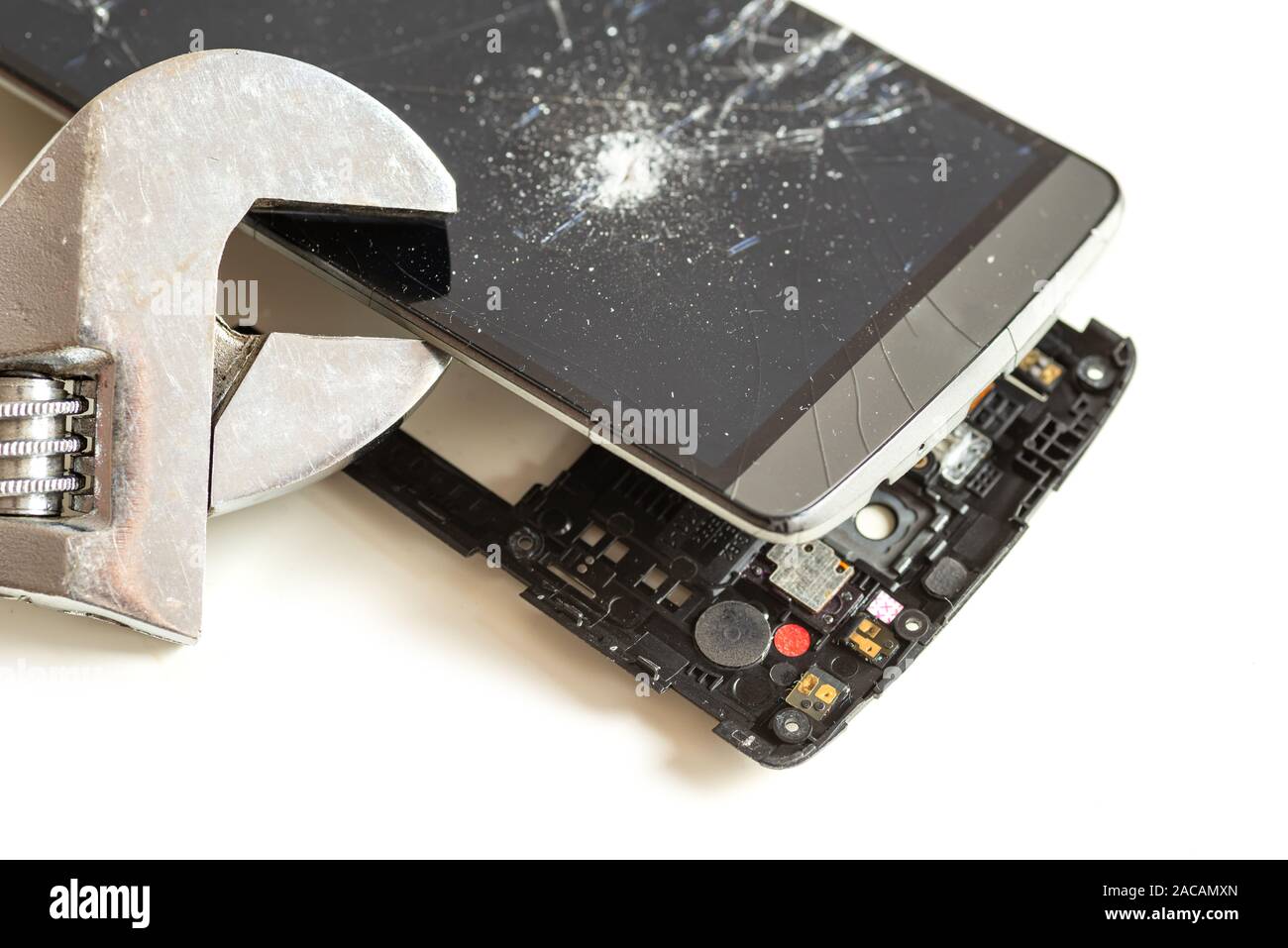 Old broken phone with an adjustable wrench Stock Photo - Alamy