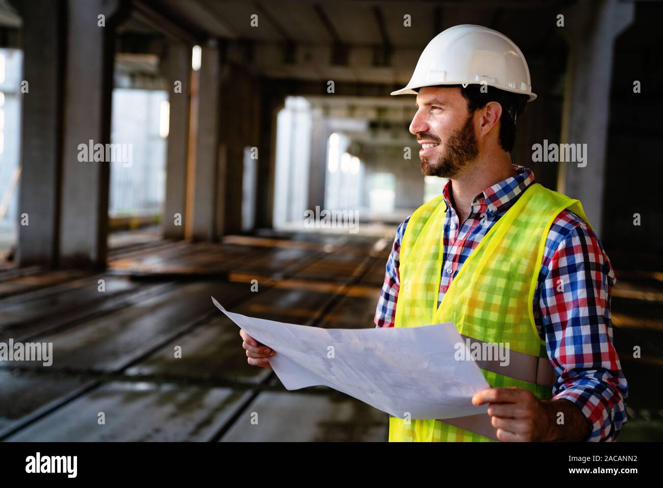 Picture of construction site engineer looking at blueprint Stock Photo ...