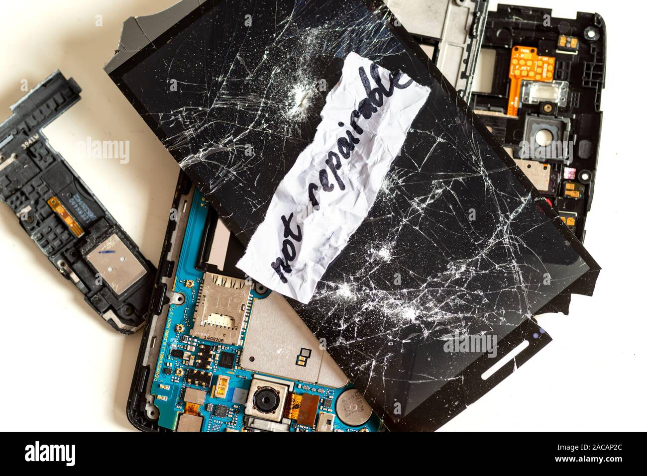 Old broken phone that cannot be repaired isolated on white background ...