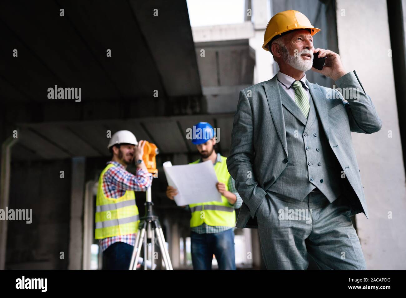 Team of construction engineers, architects working on building site ...