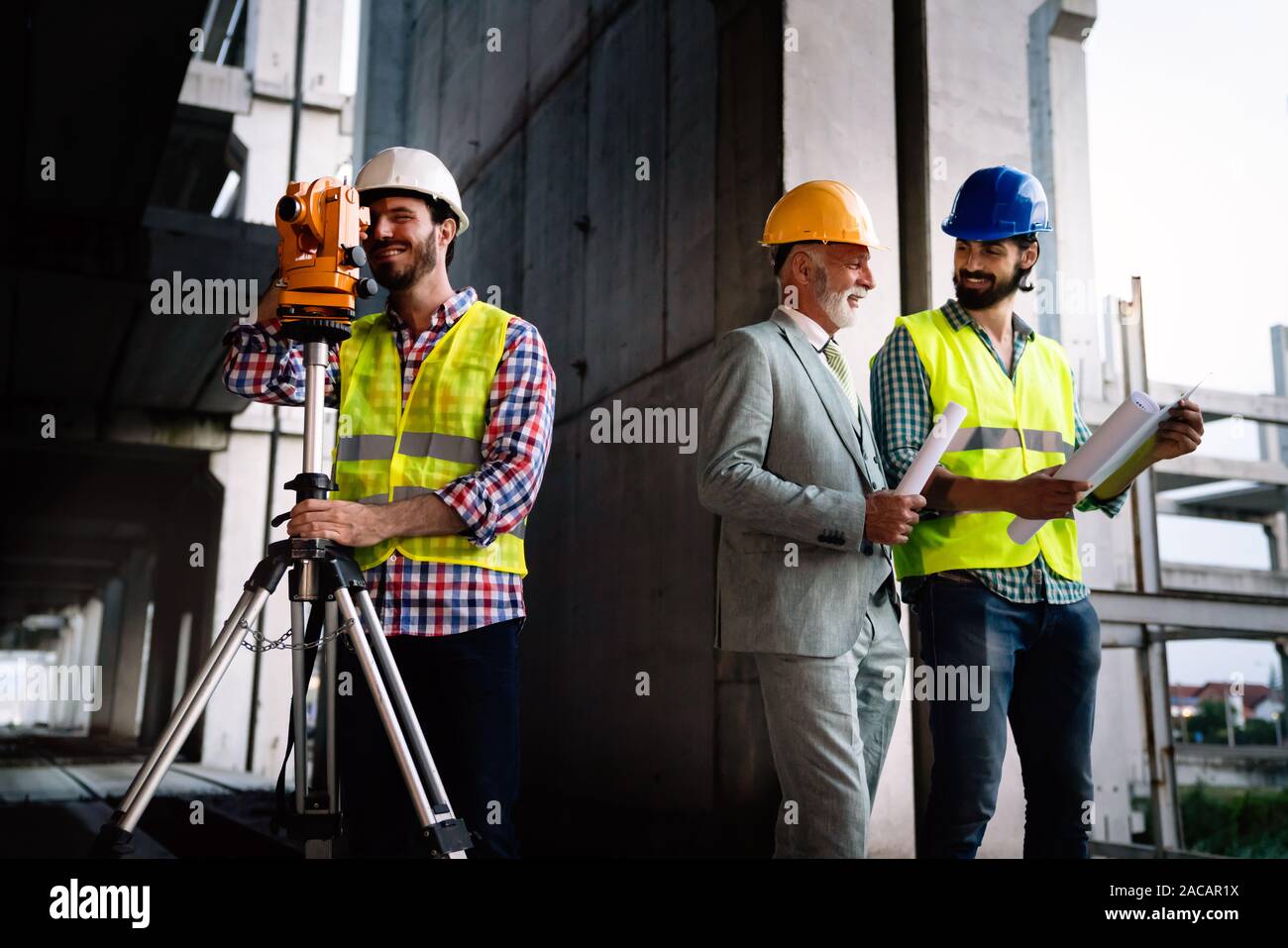 Team of construction engineers, architects working on building site ...