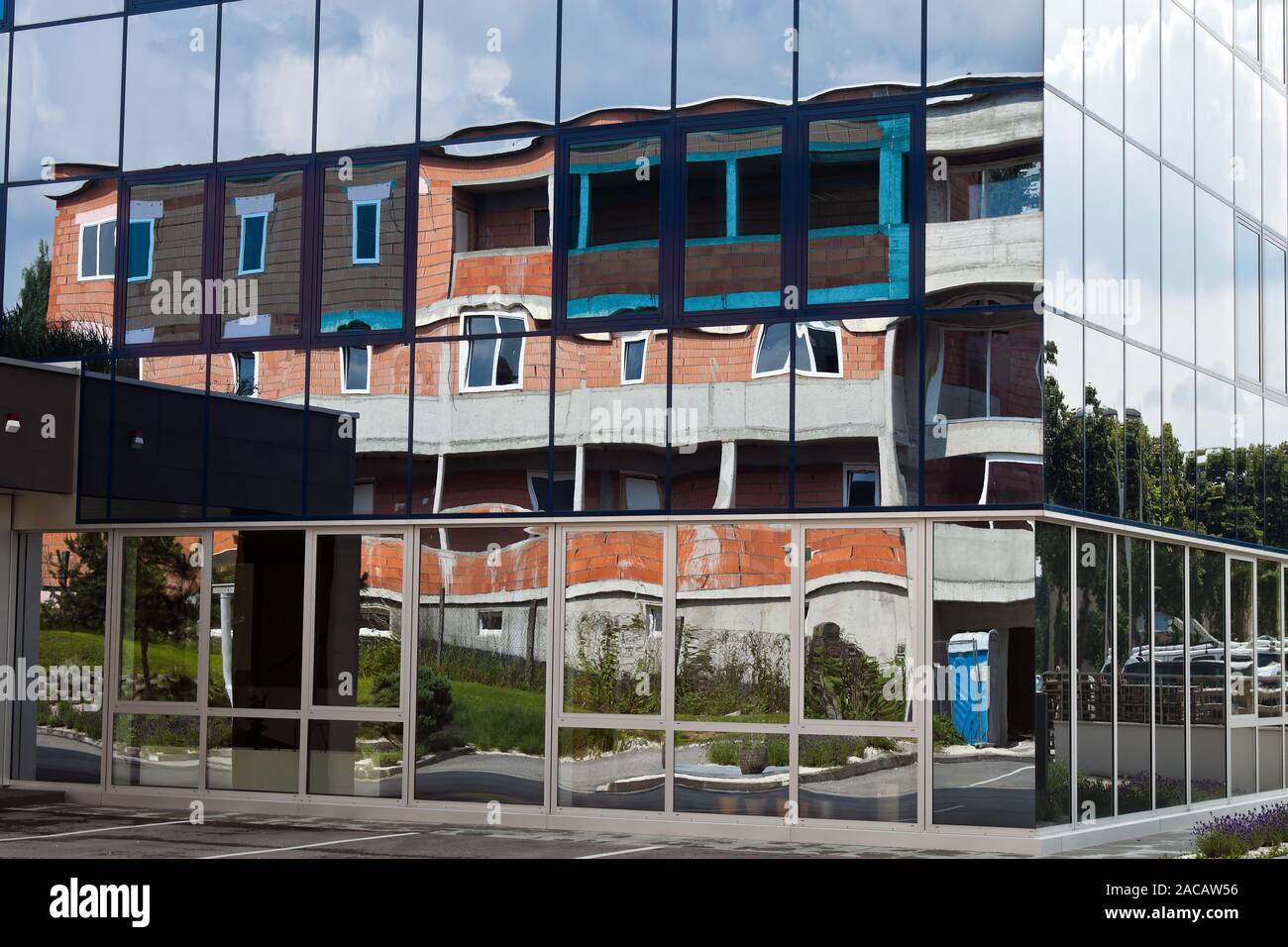 The shell of a residential building is reflected in the façade Stock ...