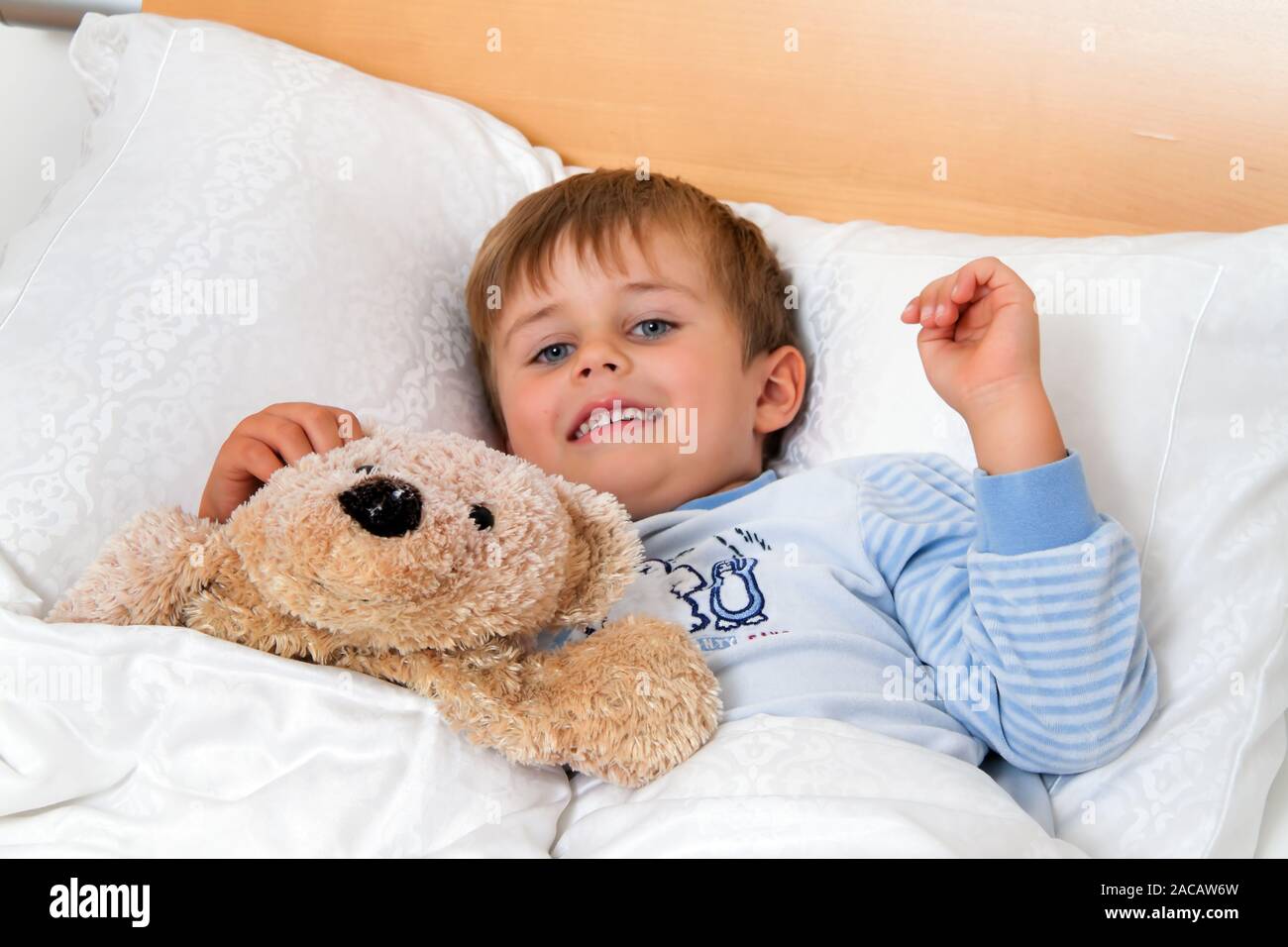 Child lying in bed in bedroom Stock Photo - Alamy