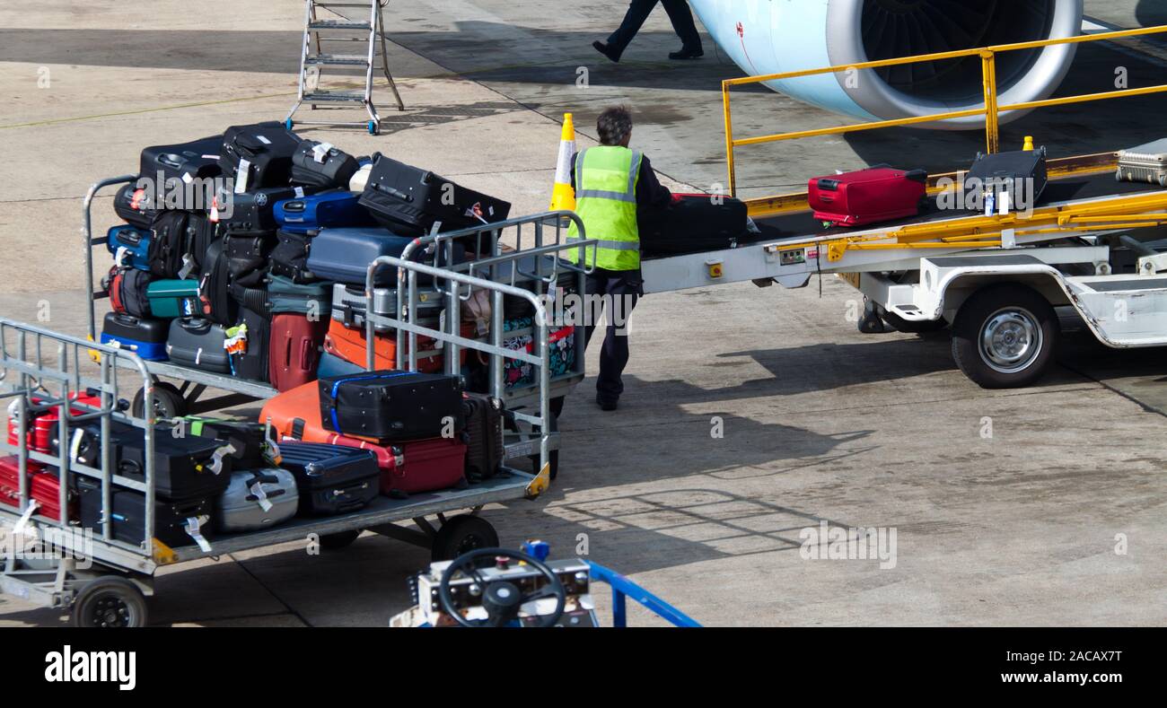 Suitcases and flight luggage in aircraft Stock Photo - Alamy
