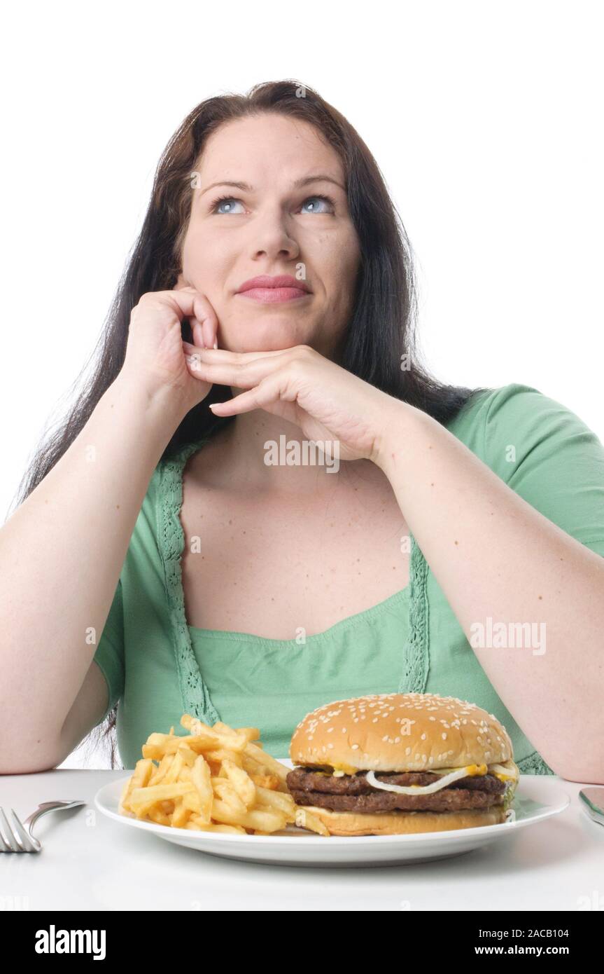 Overweight adult woman eats fast food Stock Photo - Alamy