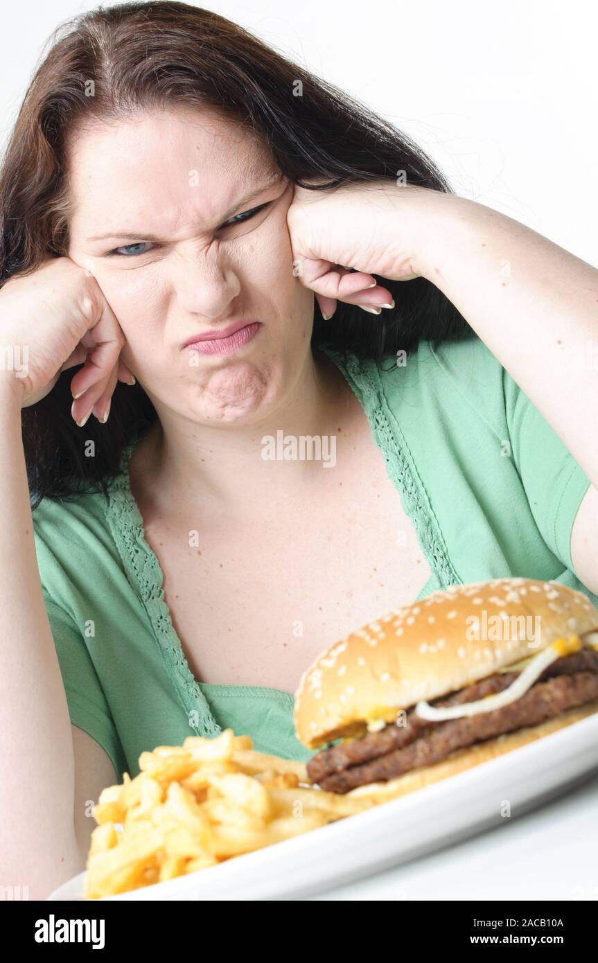 Overweight adult woman eats fast food Stock Photo - Alamy