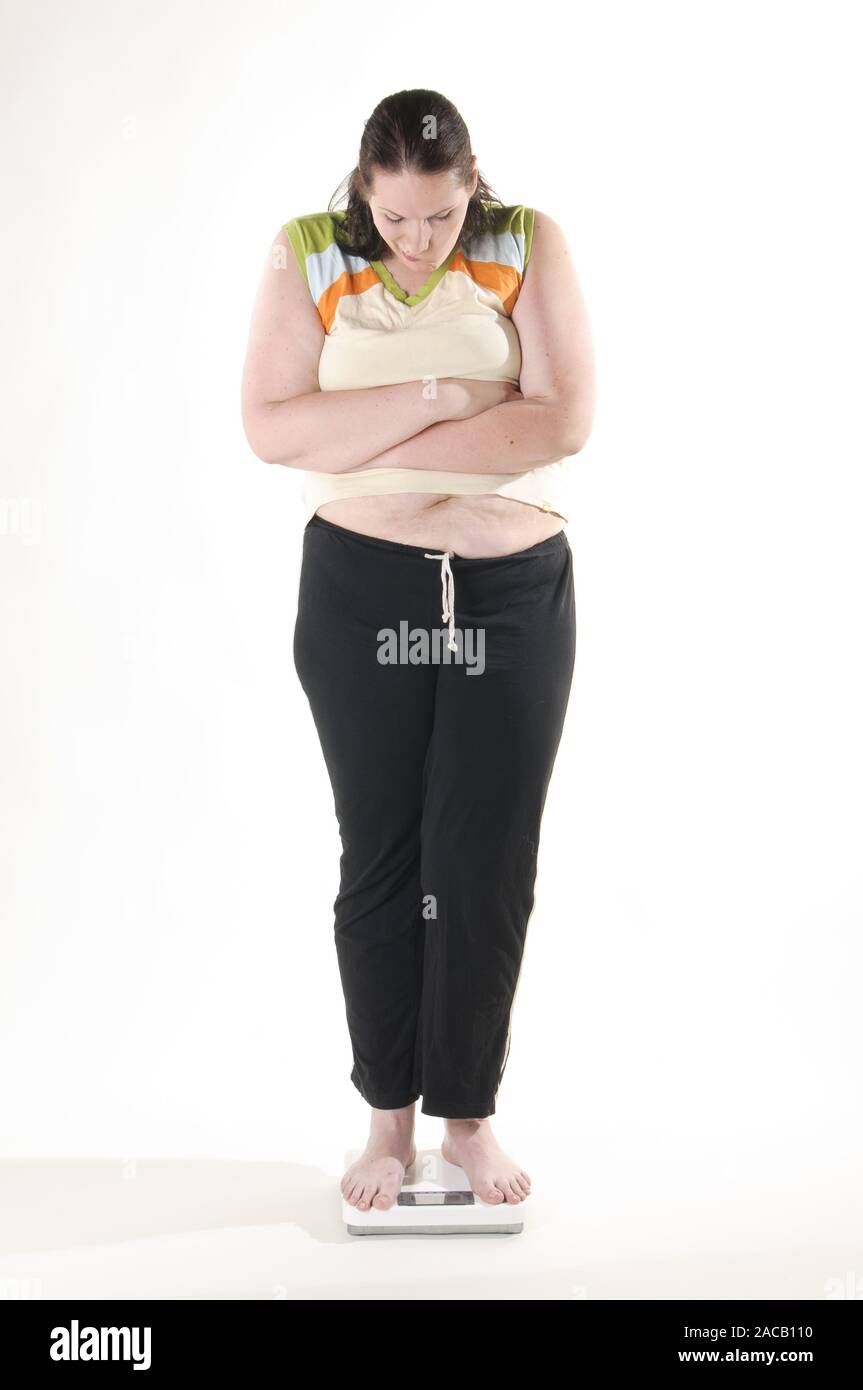 Overweight adult woman on the scales Stock Photo - Alamy