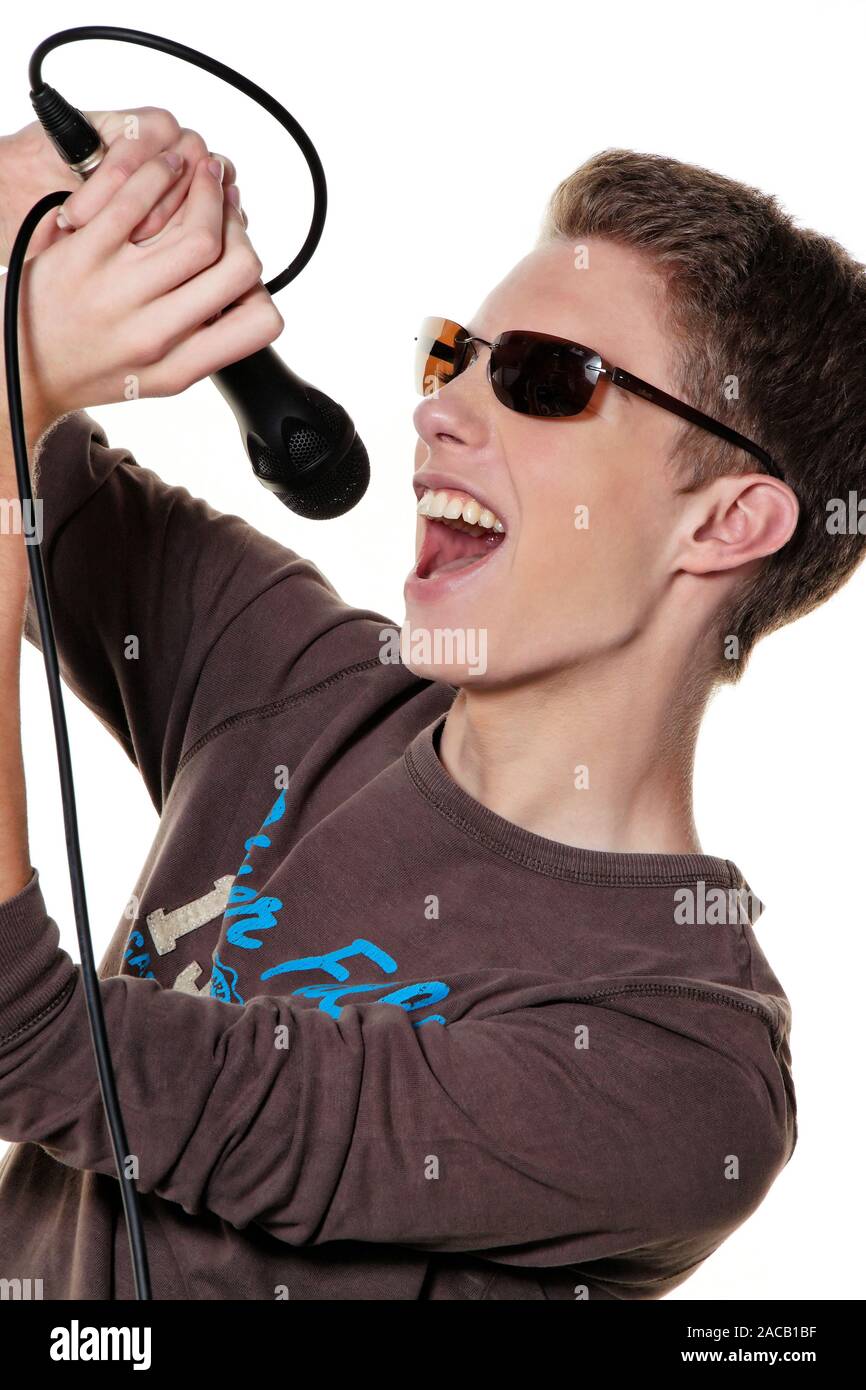 Young singer with microphone Stock Photo - Alamy