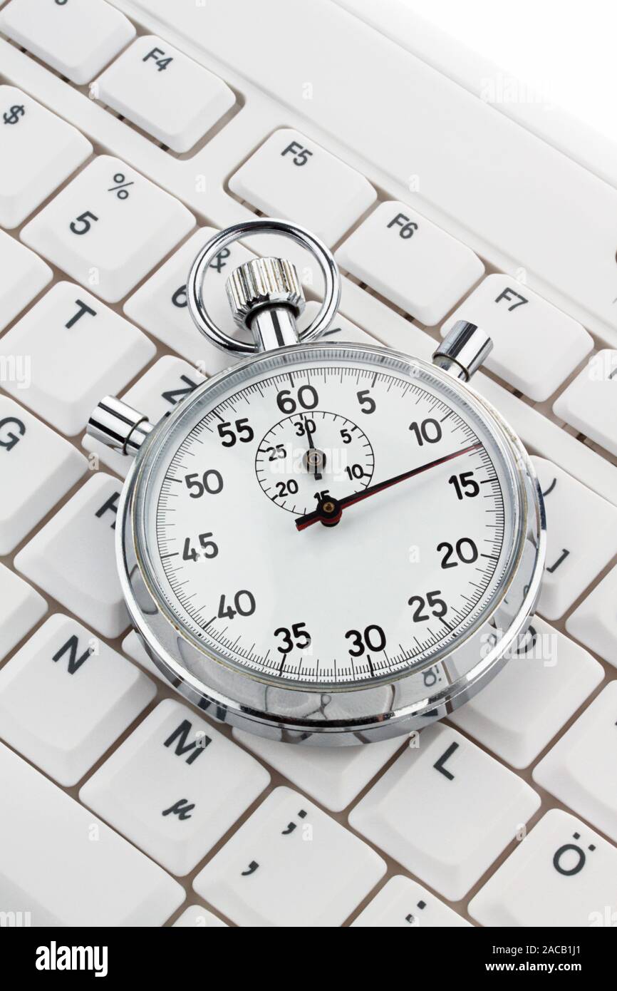 Clock on computer keyboard Stock Photo - Alamy