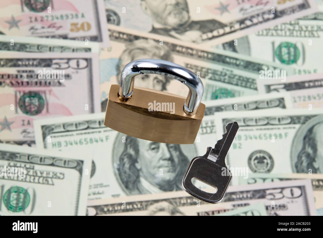 Dollar banknotes with lock Stock Photo - Alamy