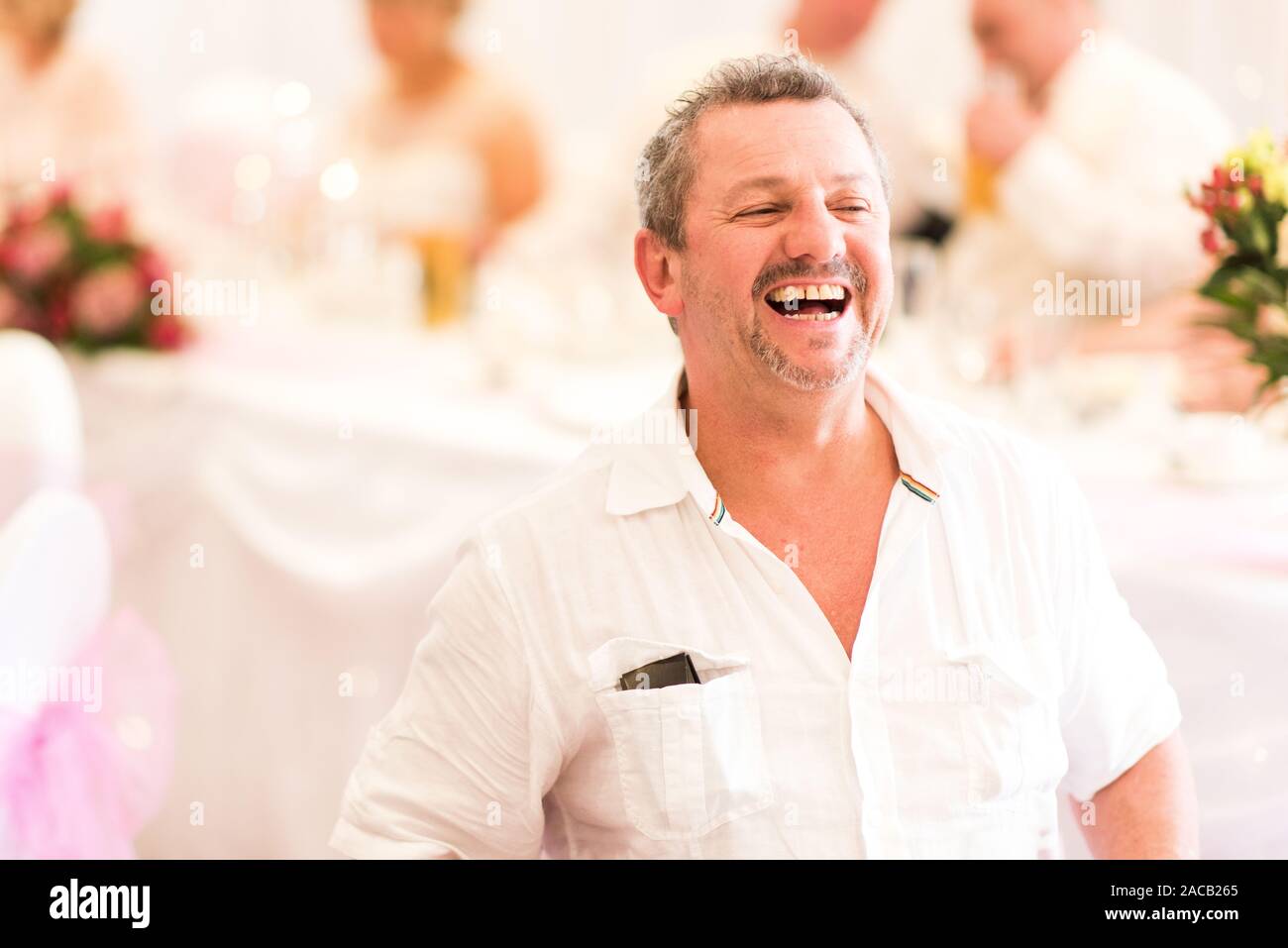 Wedding guests smiling, laughing and having fun at the wedding ...
