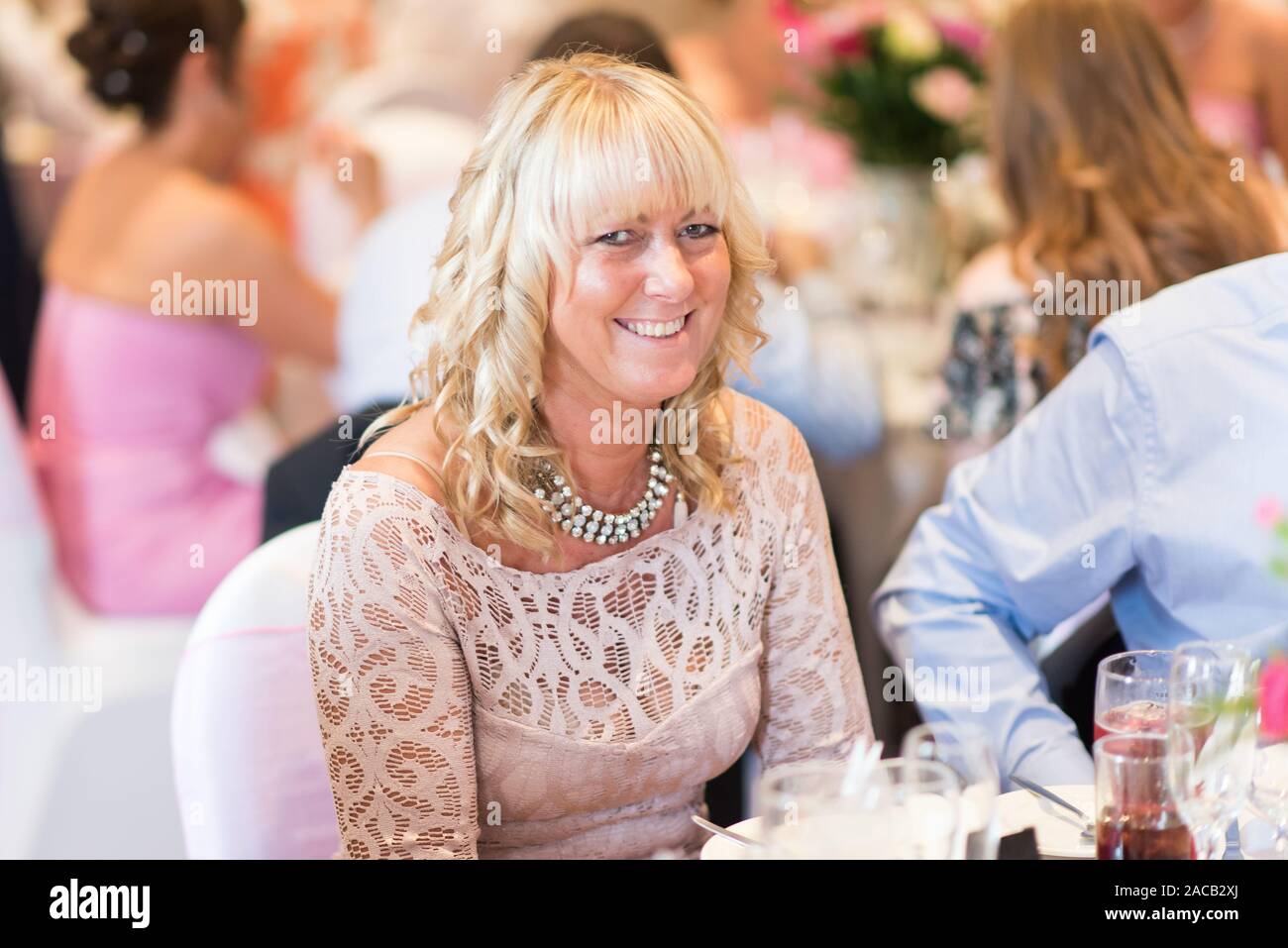 Wedding guests smiling, laughing and having fun at the wedding ...