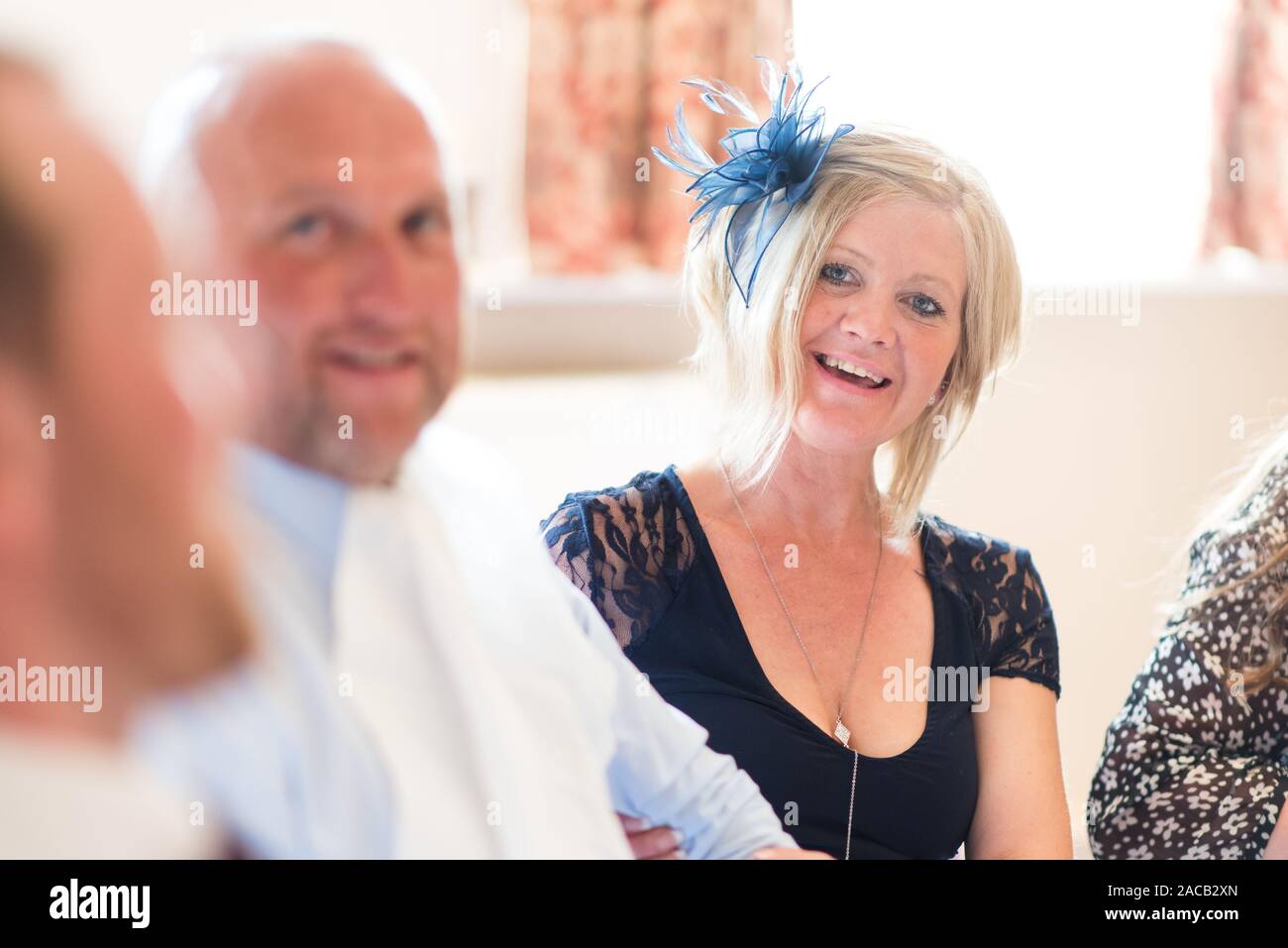 Wedding guests smiling, laughing and having fun at the wedding ...