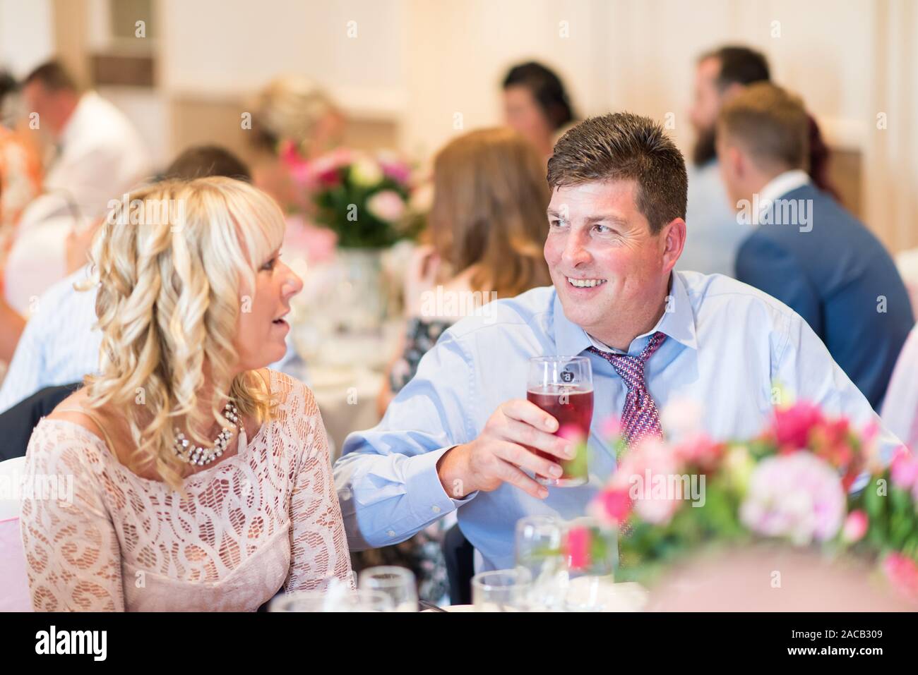 Wedding guests smiling, laughing and having fun at the wedding ...