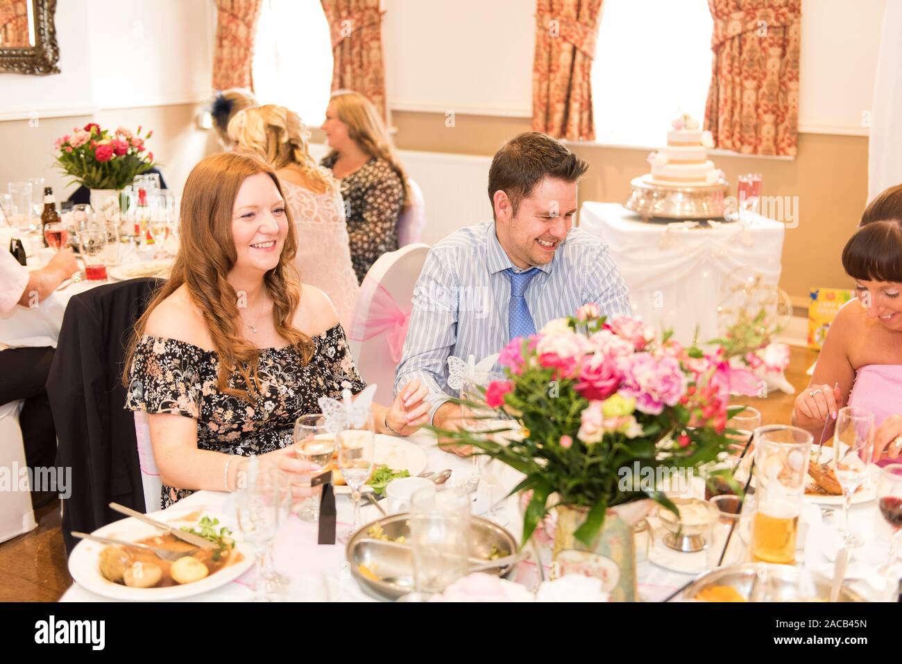 Wedding guests smiling, laughing and having fun at the wedding ...