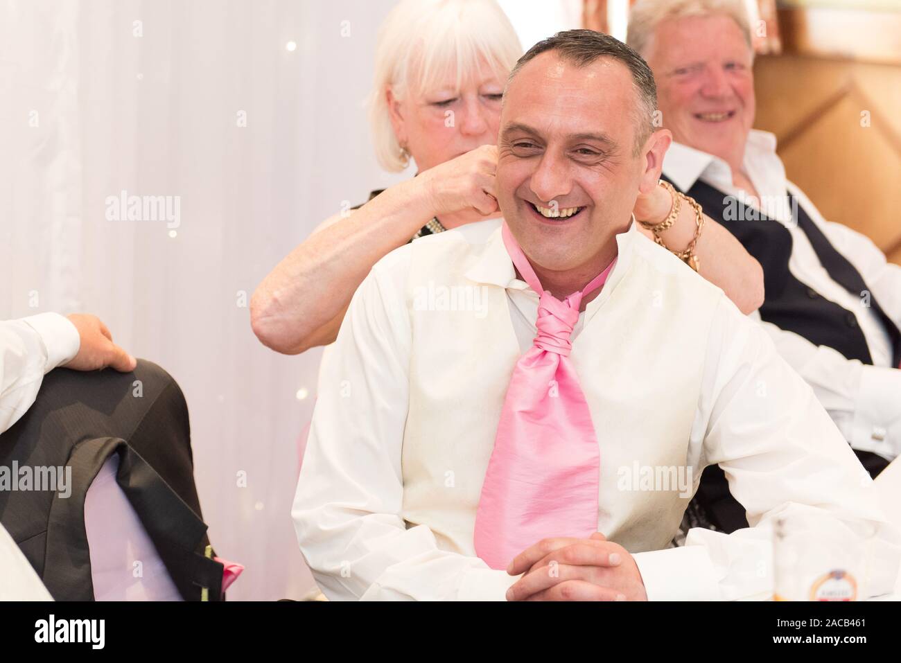 Wedding guests smiling, laughing and having fun at the wedding ...