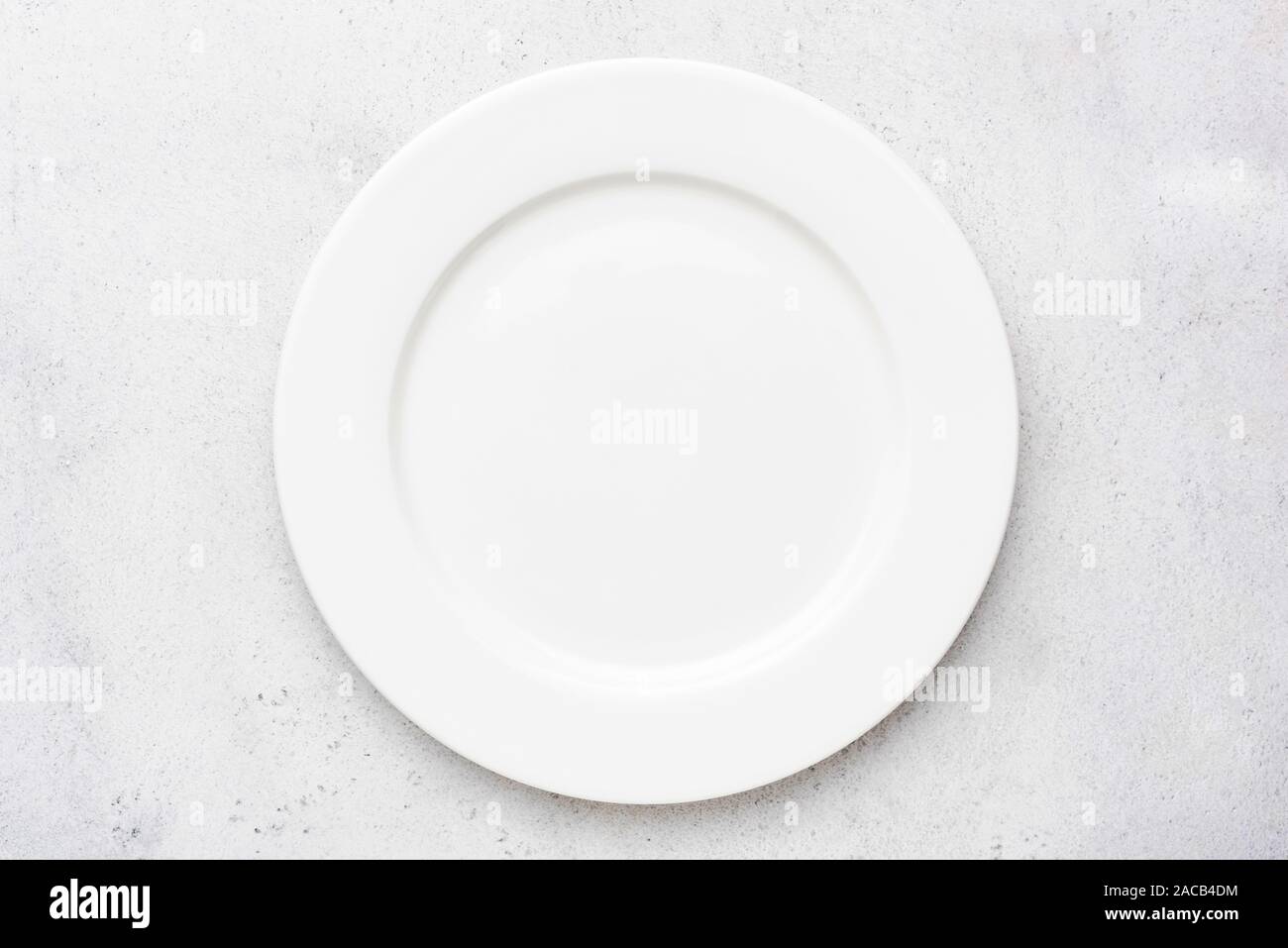Empty white plate on grey cement concrete background with copy space ...