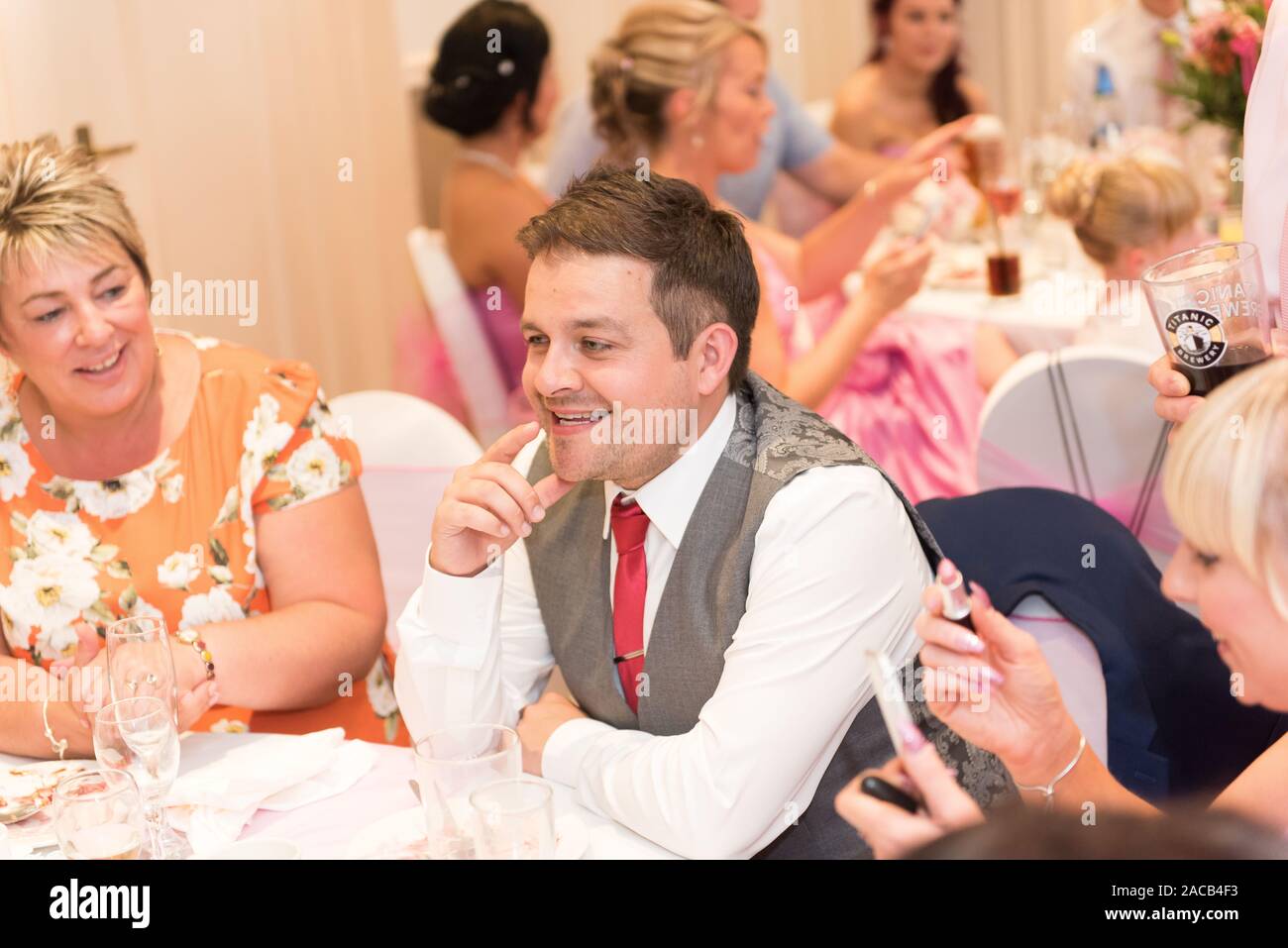 Wedding guests smiling, laughing and having fun at the wedding ...