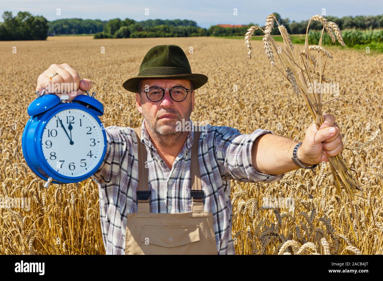 Farmer with clock 5 to 12 Stock Photo - Alamy