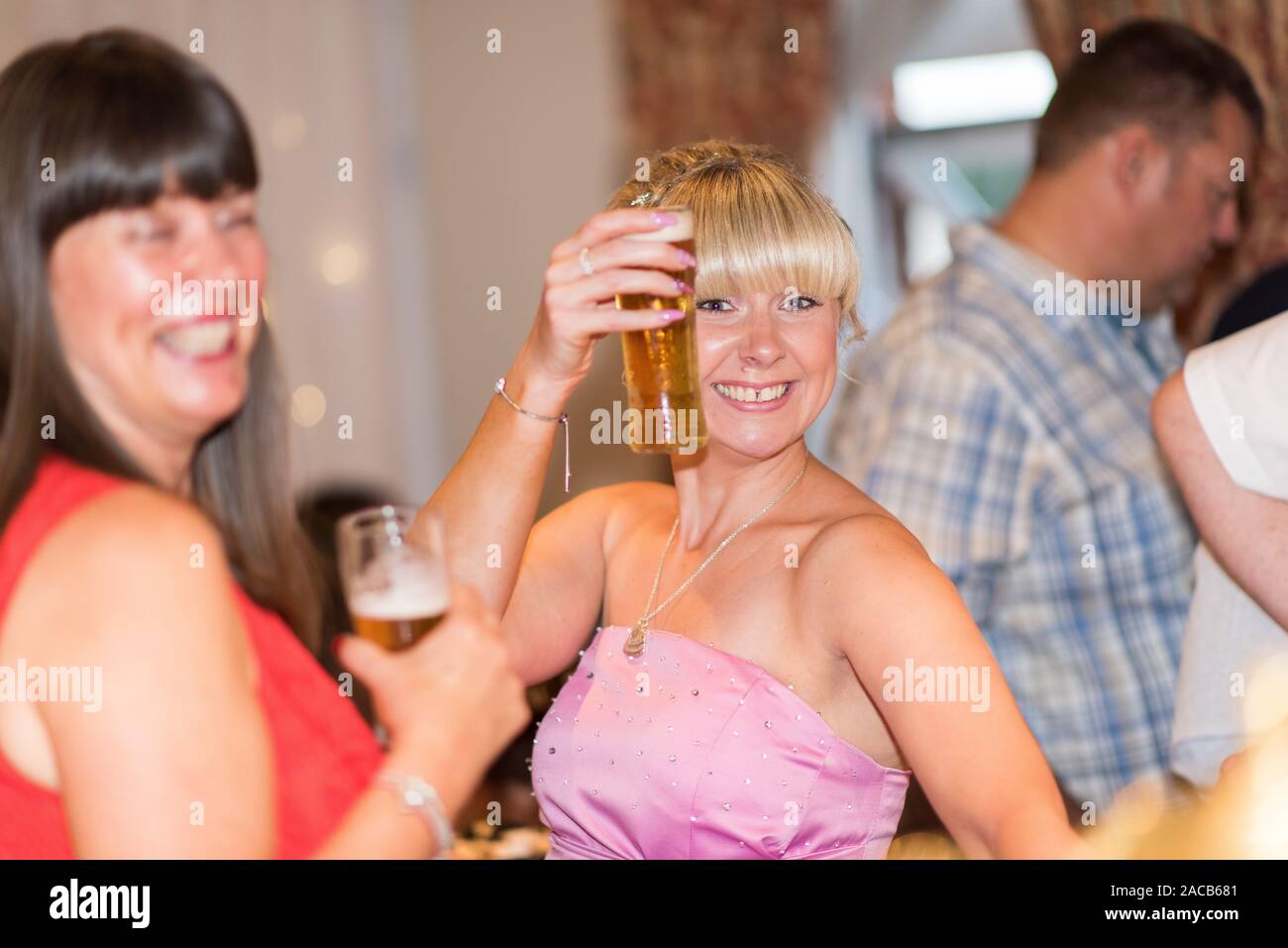 Wedding guests smiling, laughing and having fun at the wedding ...