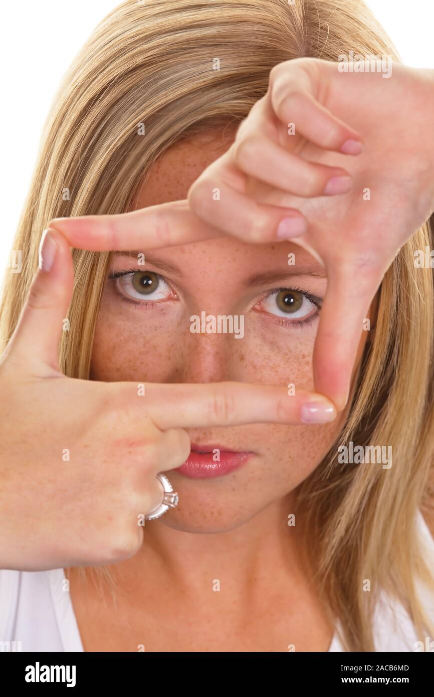 Woman looks through a frame Stock Photo - Alamy