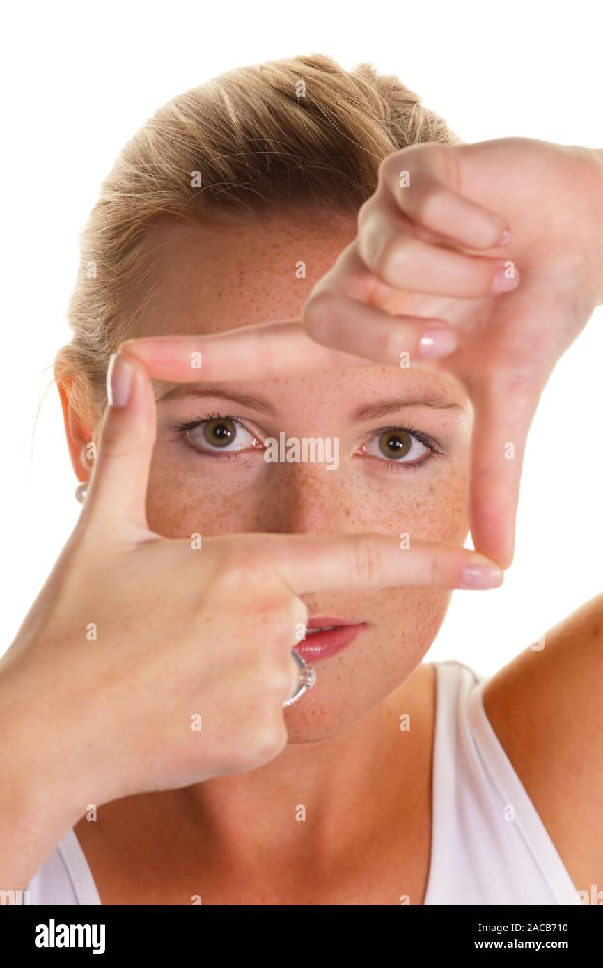 Woman looks through a frame Stock Photo - Alamy