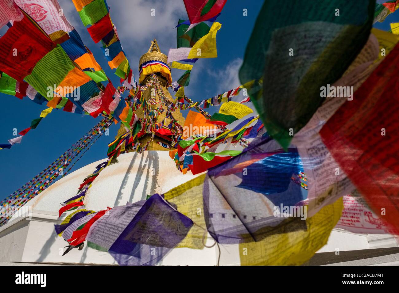 Colorful buddhist prayer flags leading to the top of the Boudha Stupa ...