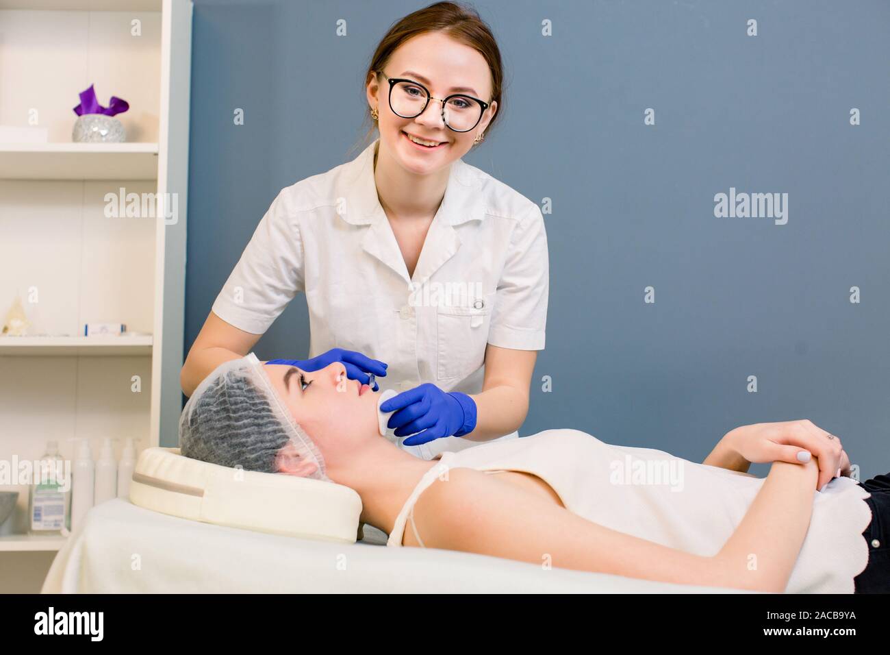 Lips injections concept. Close up. Indoor shot. Attractive young woman ...