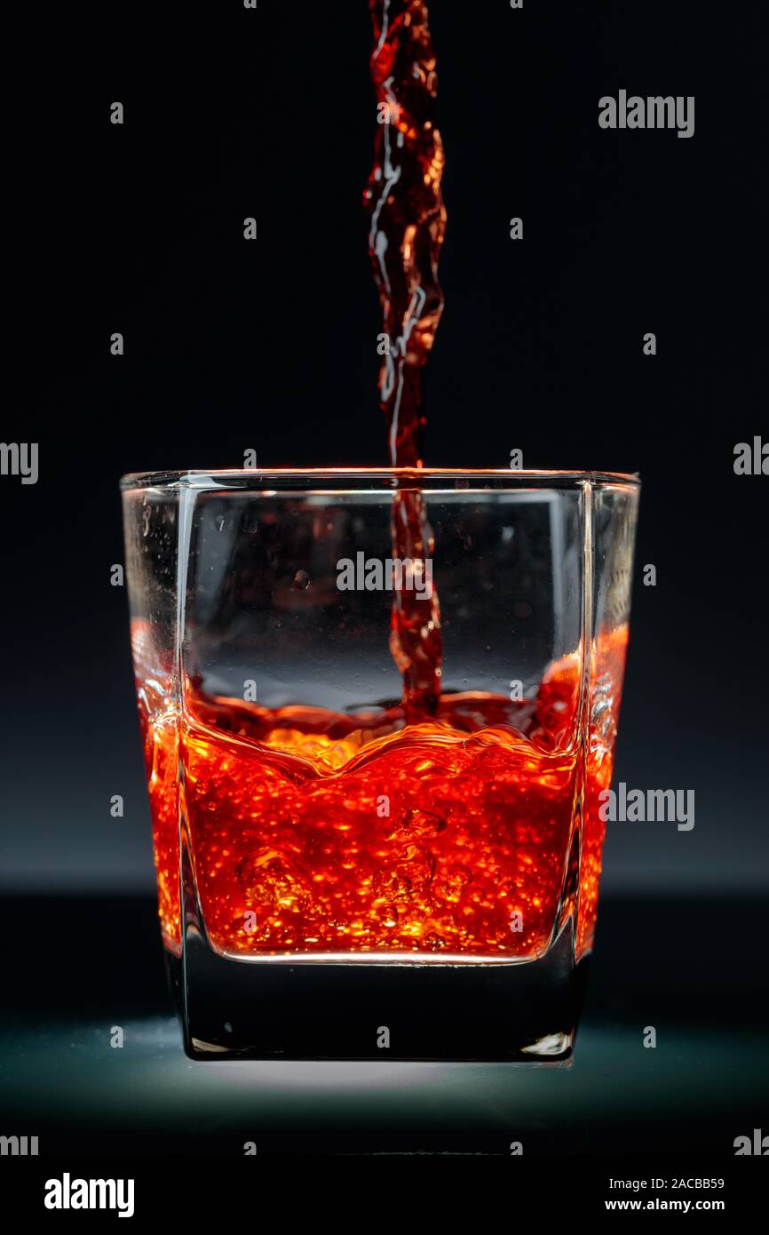 Pouring whiskey or scotch into glass. Alcoholic drink pouring into a ...