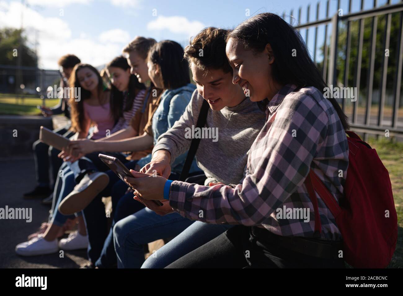 Teenagers hanging out in their school grounds Stock Photo - Alamy