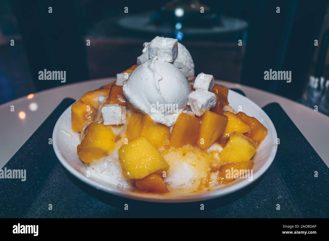 close up view of freshly made bowl of mango bingsoo - korean shaved ice ...