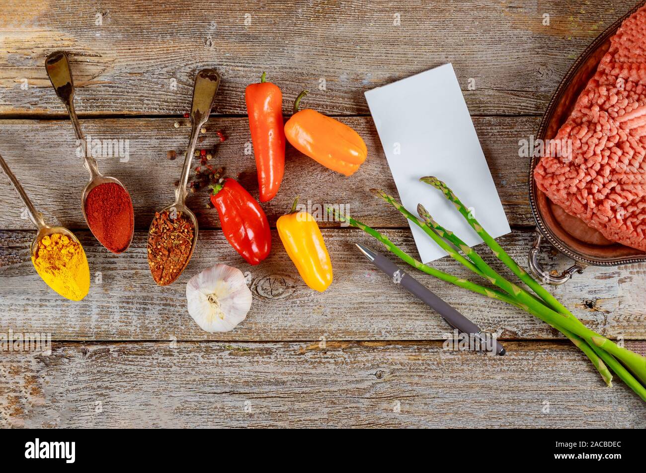Ground mince beef meat with ingredients for cooking on dark background ...