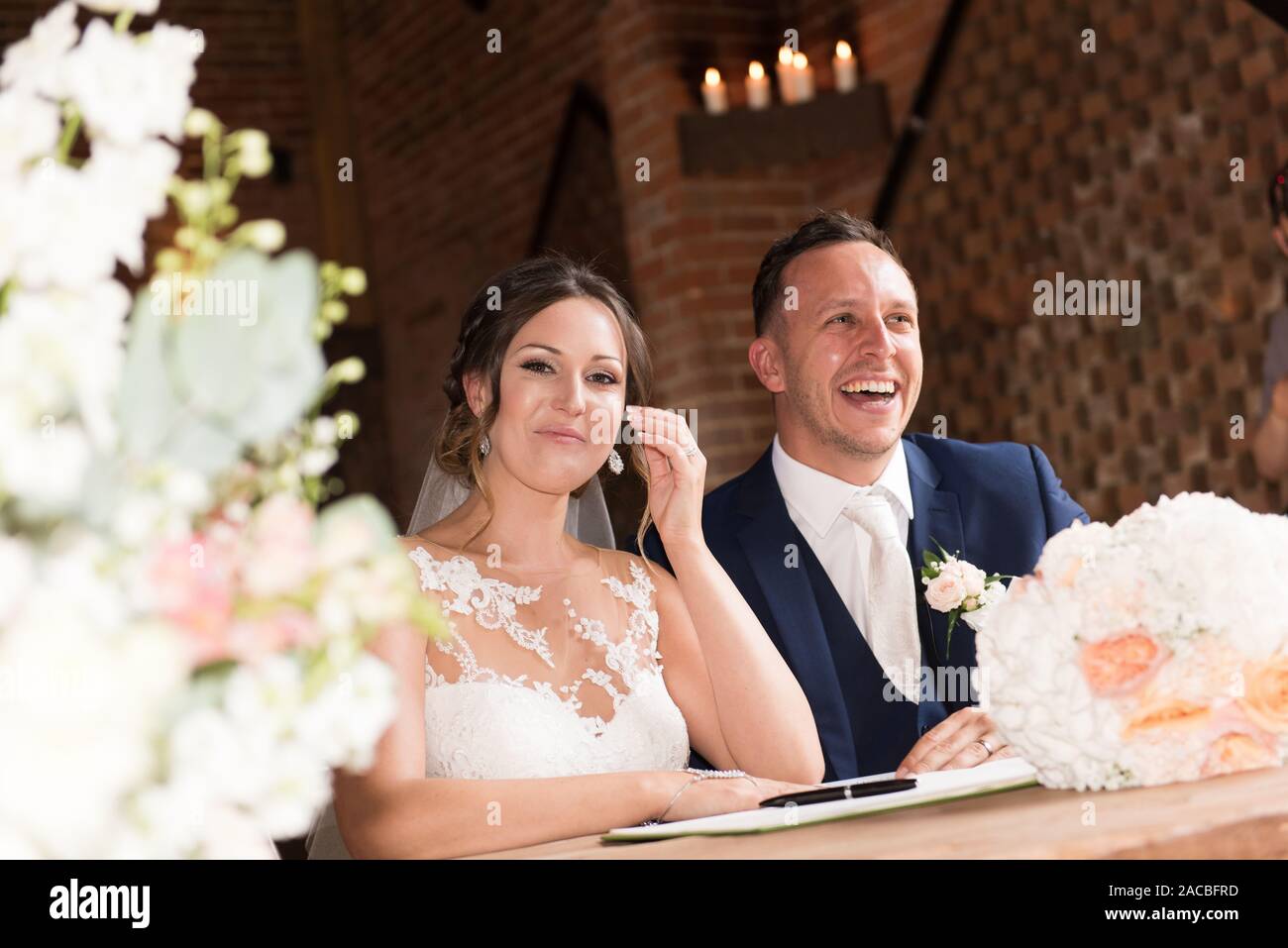 A bride and groom smiling, laughing together happy and in love on their ...