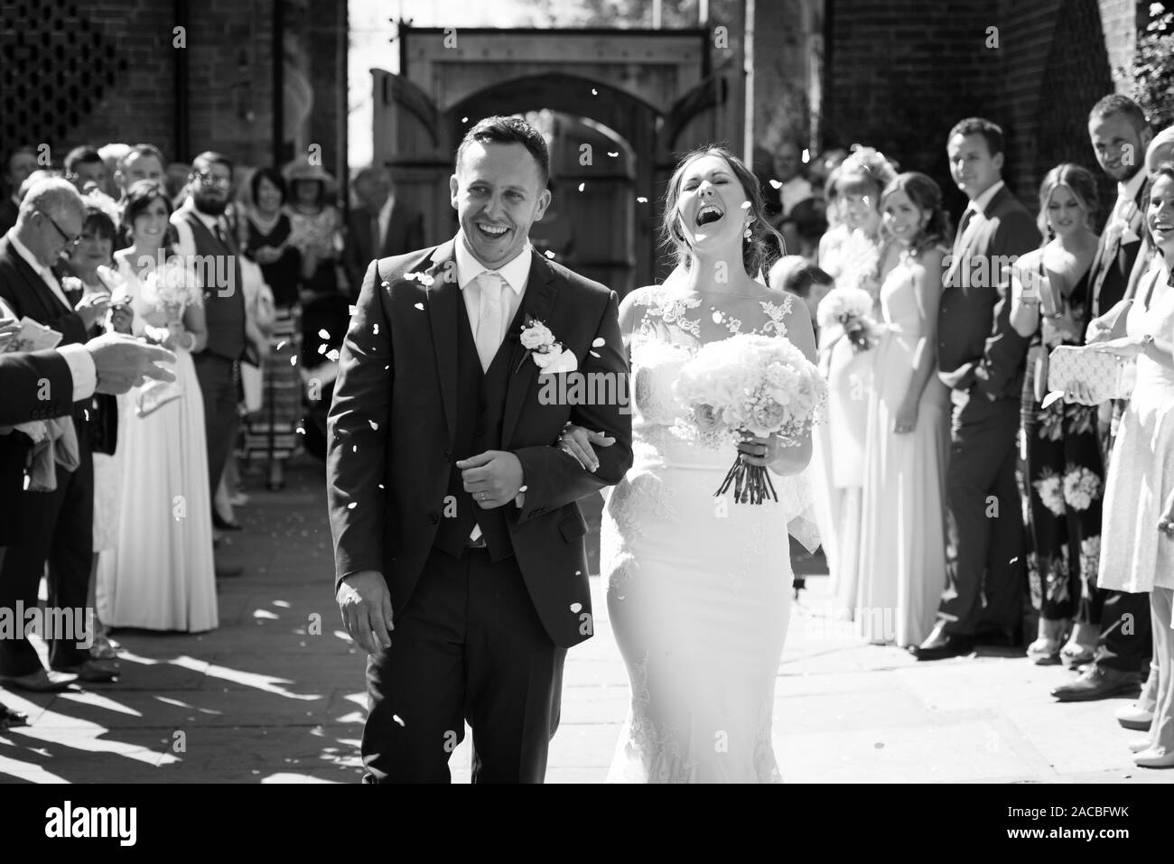 A bride and groom smiling, laughing together happy and in love on their ...