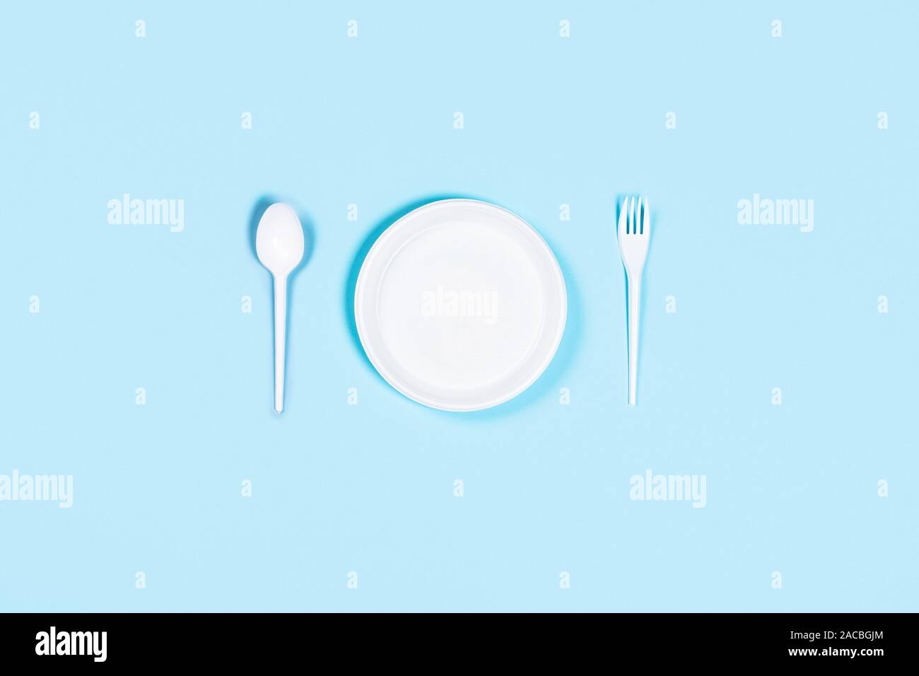 Plastic concept. Bad utensils on blue background. Flat lay, top view ...